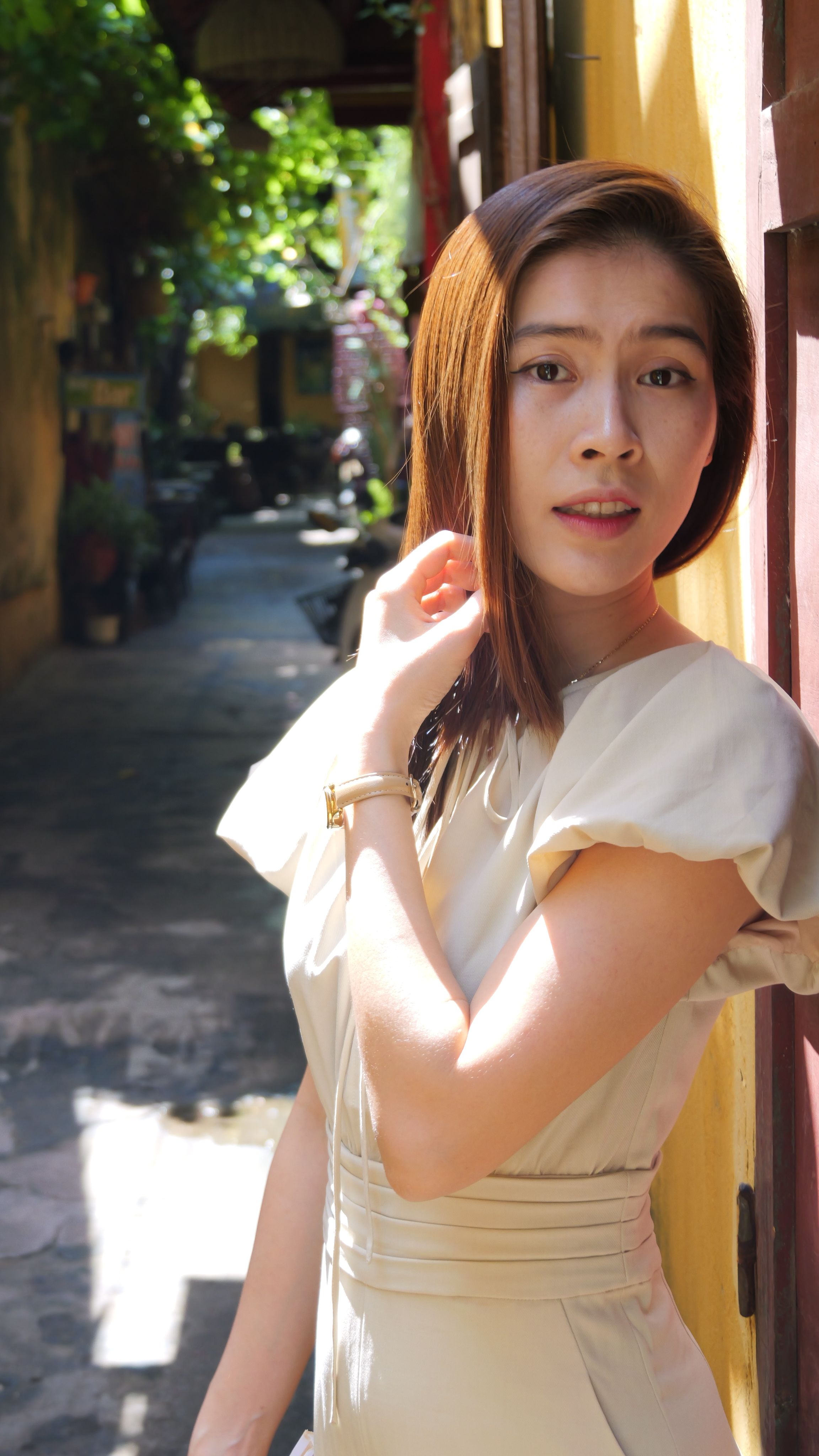Young Woman in a Light Beige Dress with Short Puffed Sleeves · Free ...
