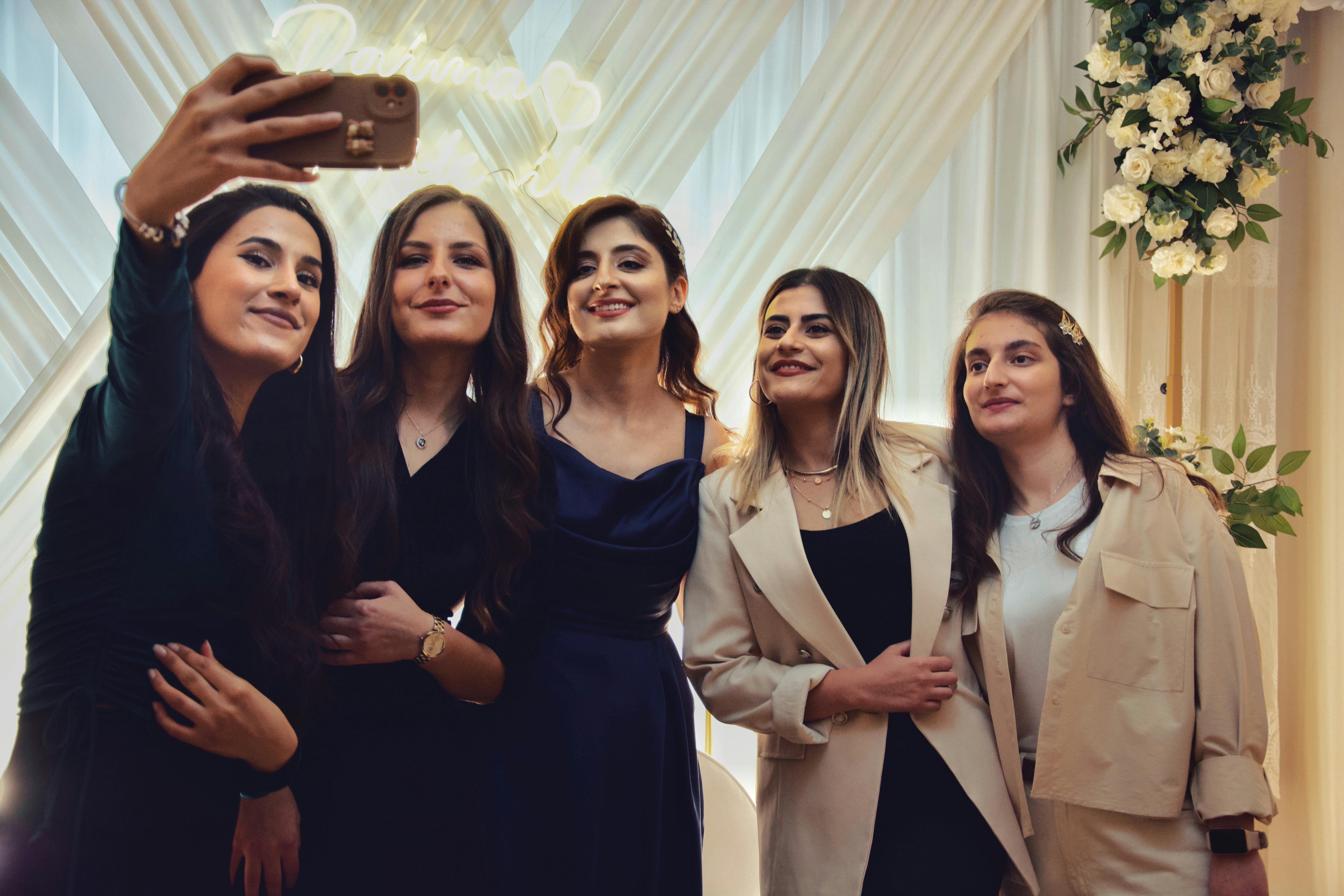 Young Girls Taking a Group Selfie · Free Stock Photo