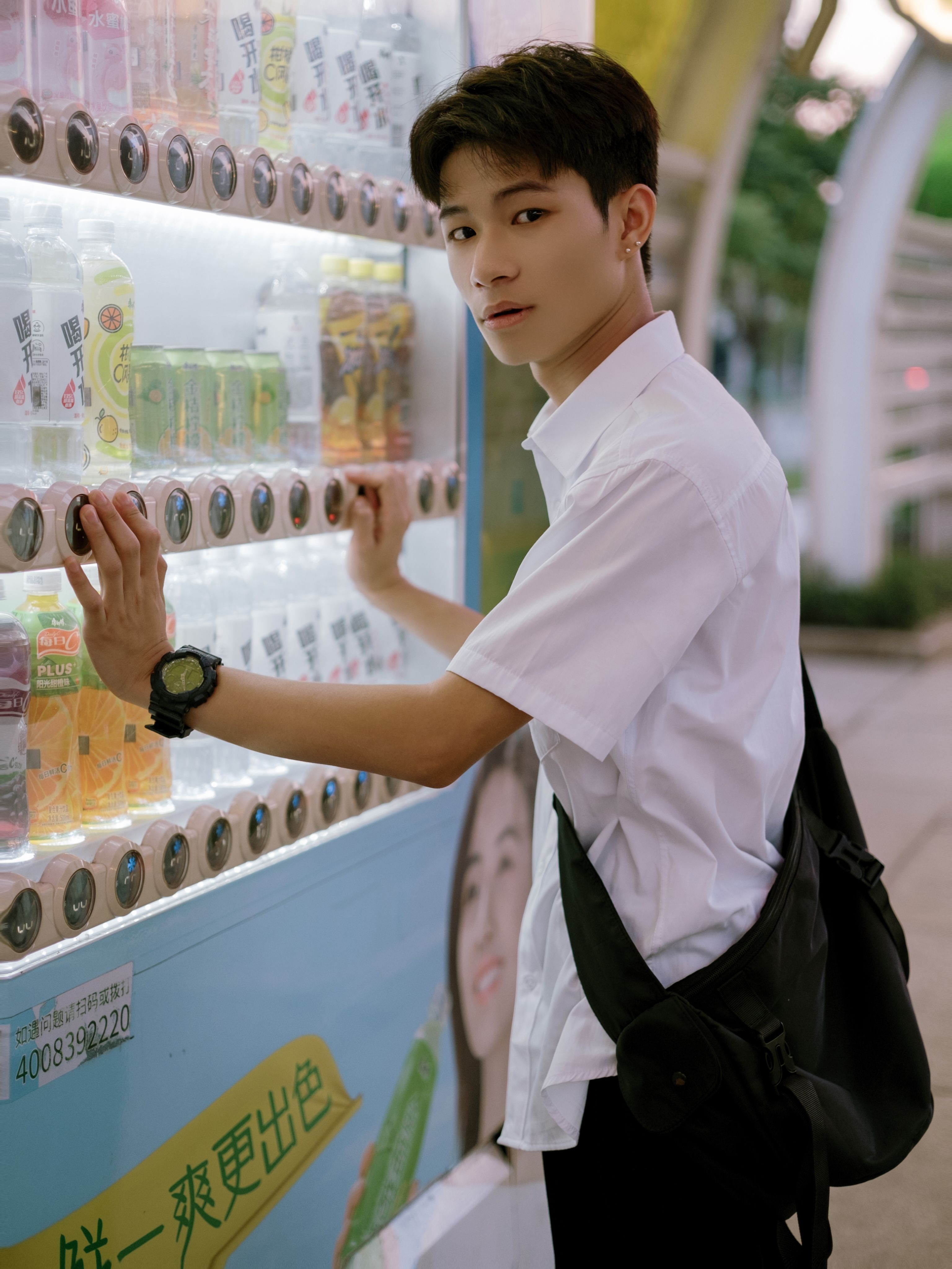 Handsome Teenage Boy Standing next to a Vending Machine · Free Stock Photo