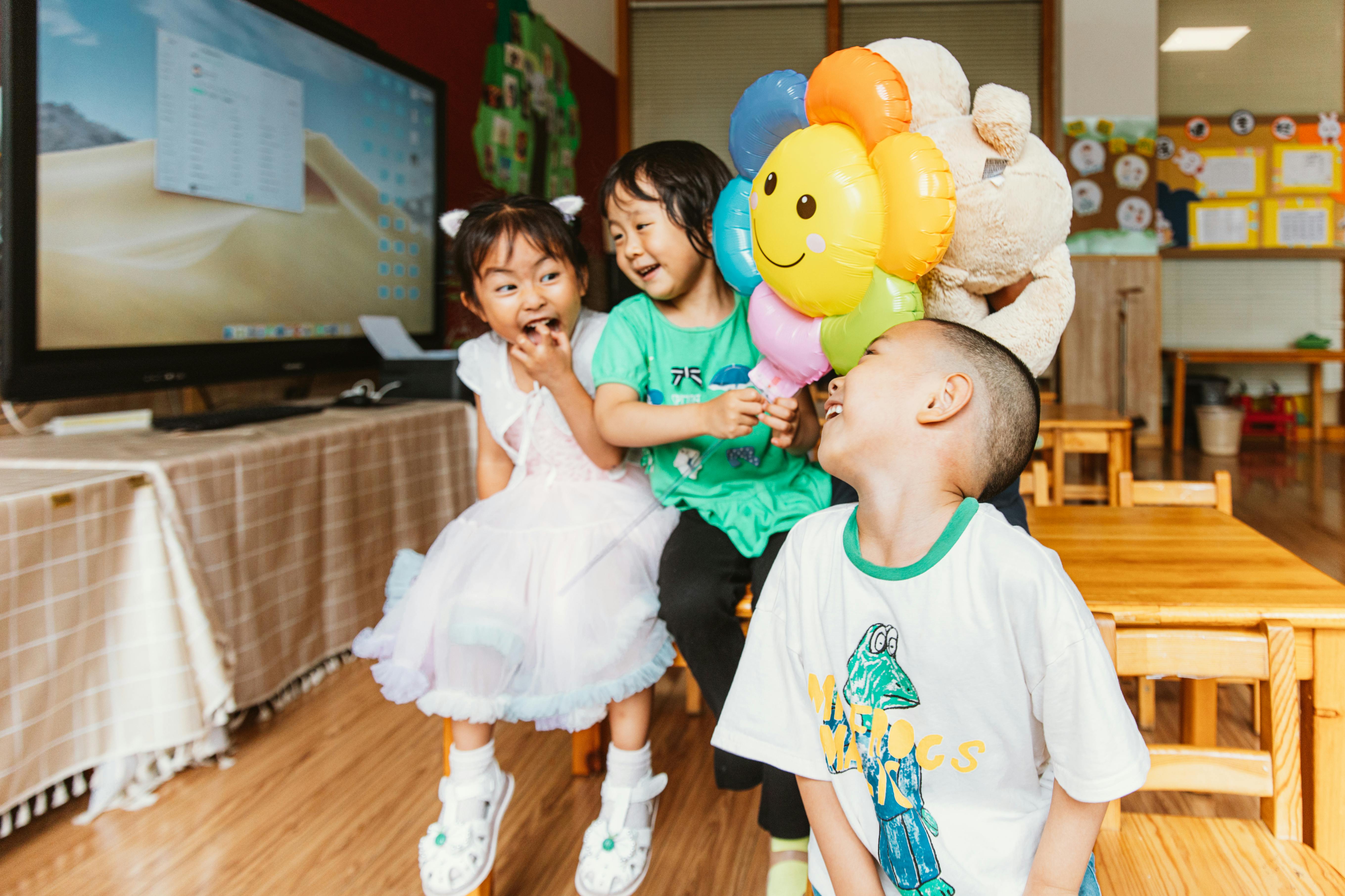 Children with Balloons in a Classroom · Free Stock Photo