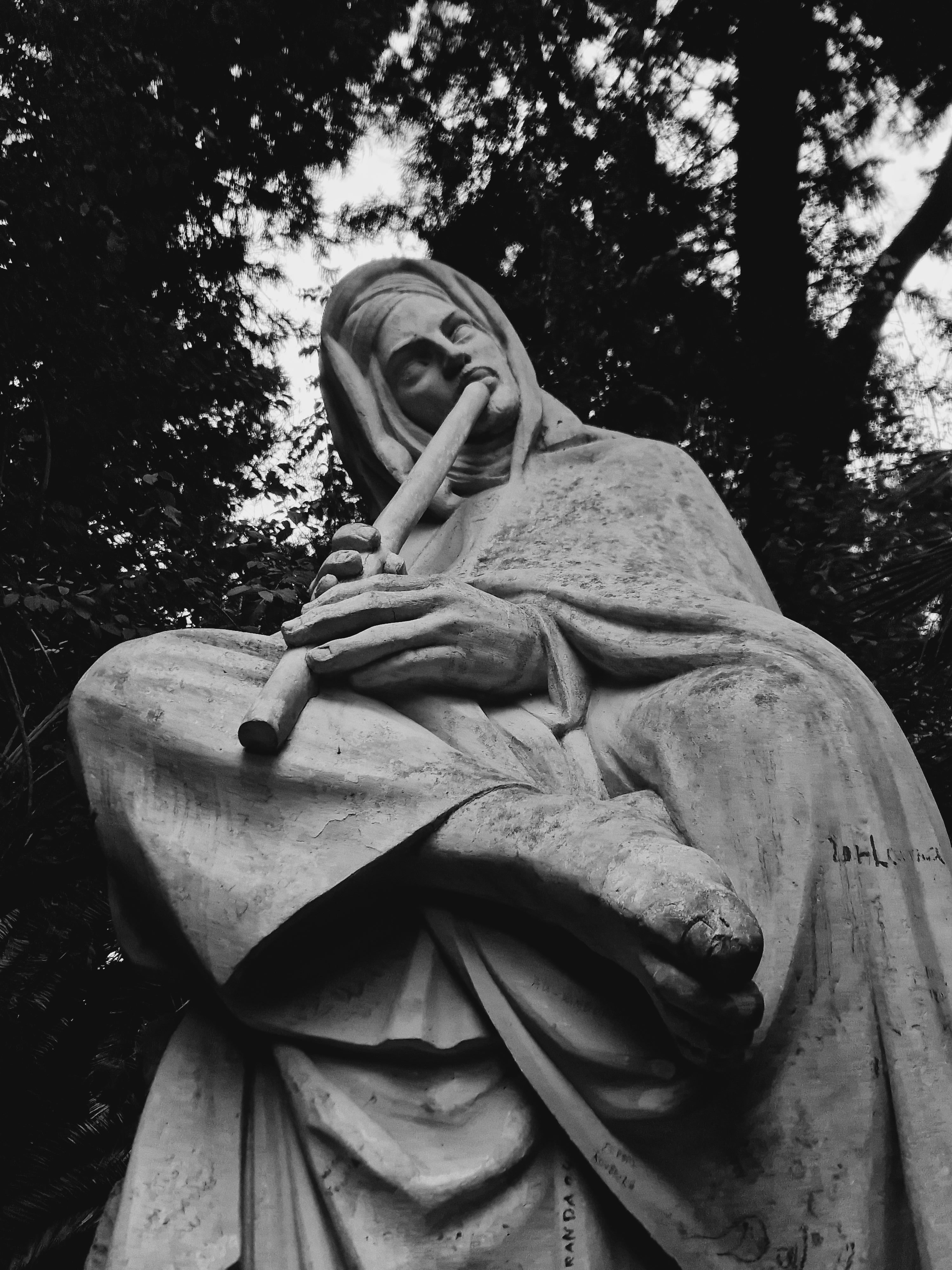 Statue of Person Playing Flute · Free Stock Photo