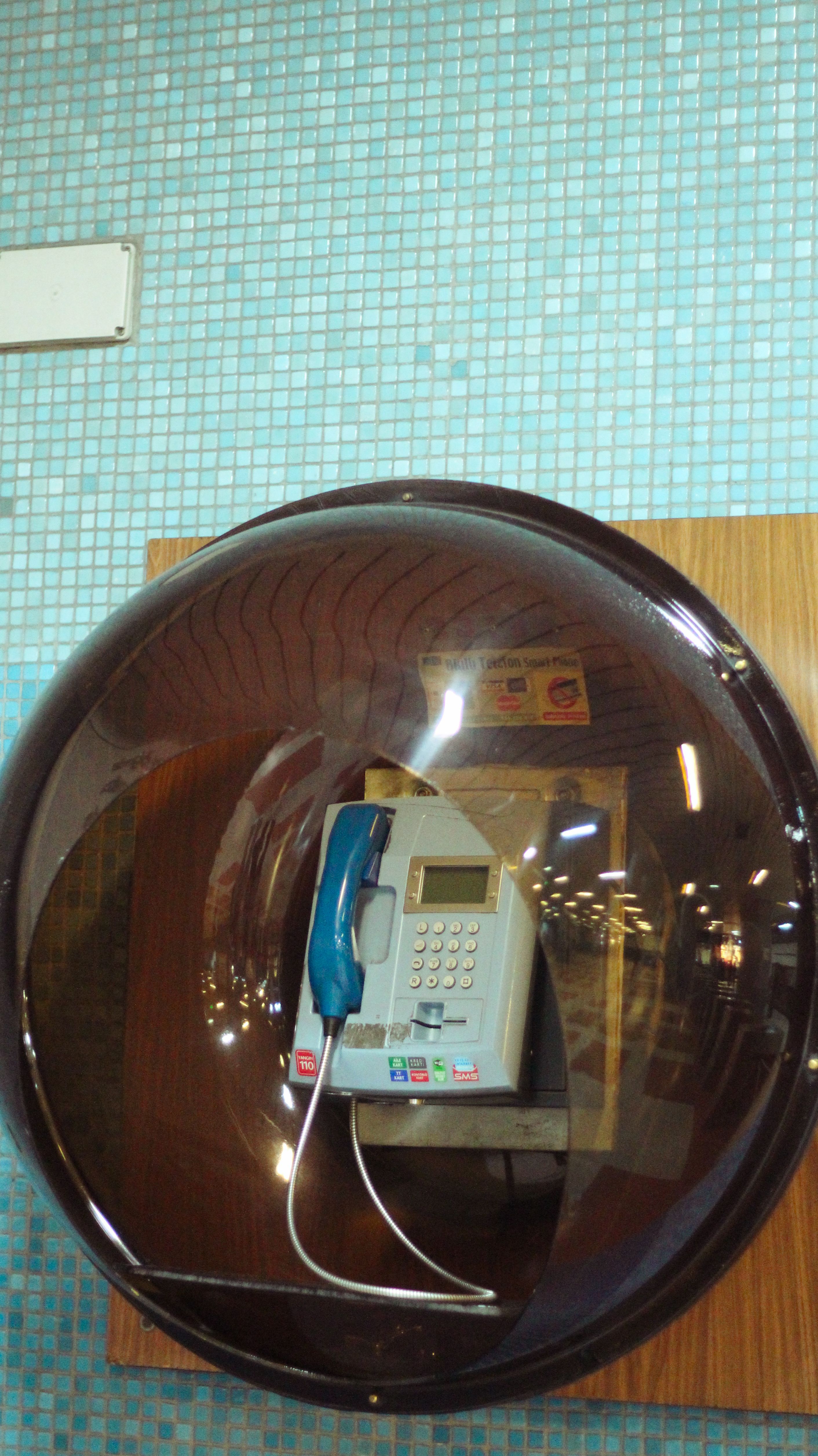 A Payphone with a Circular Plastic Cover Attached to a Wall · Free ...