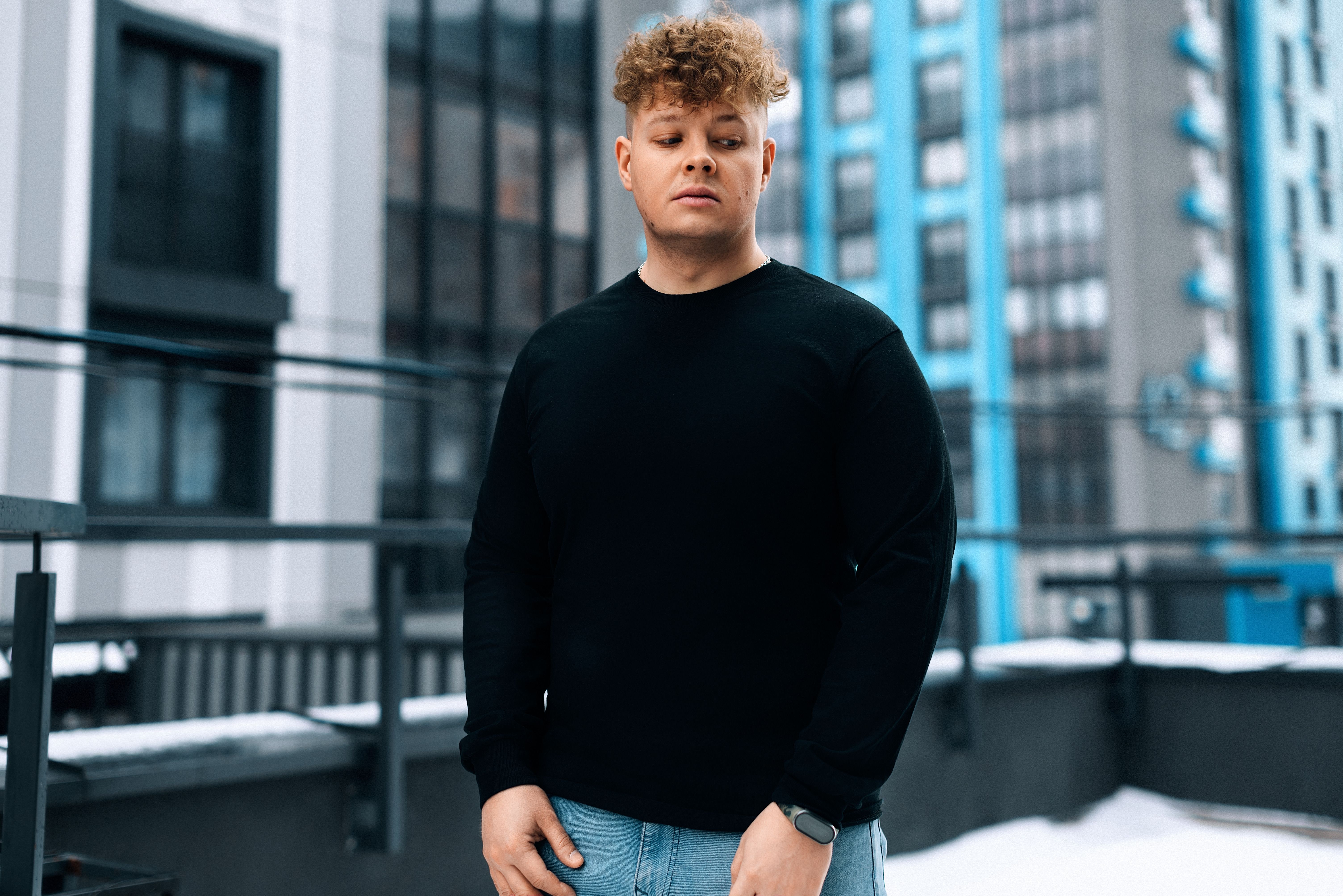 Young Man in a Black Sweatshirt Standing on a Terrace in City · Free ...