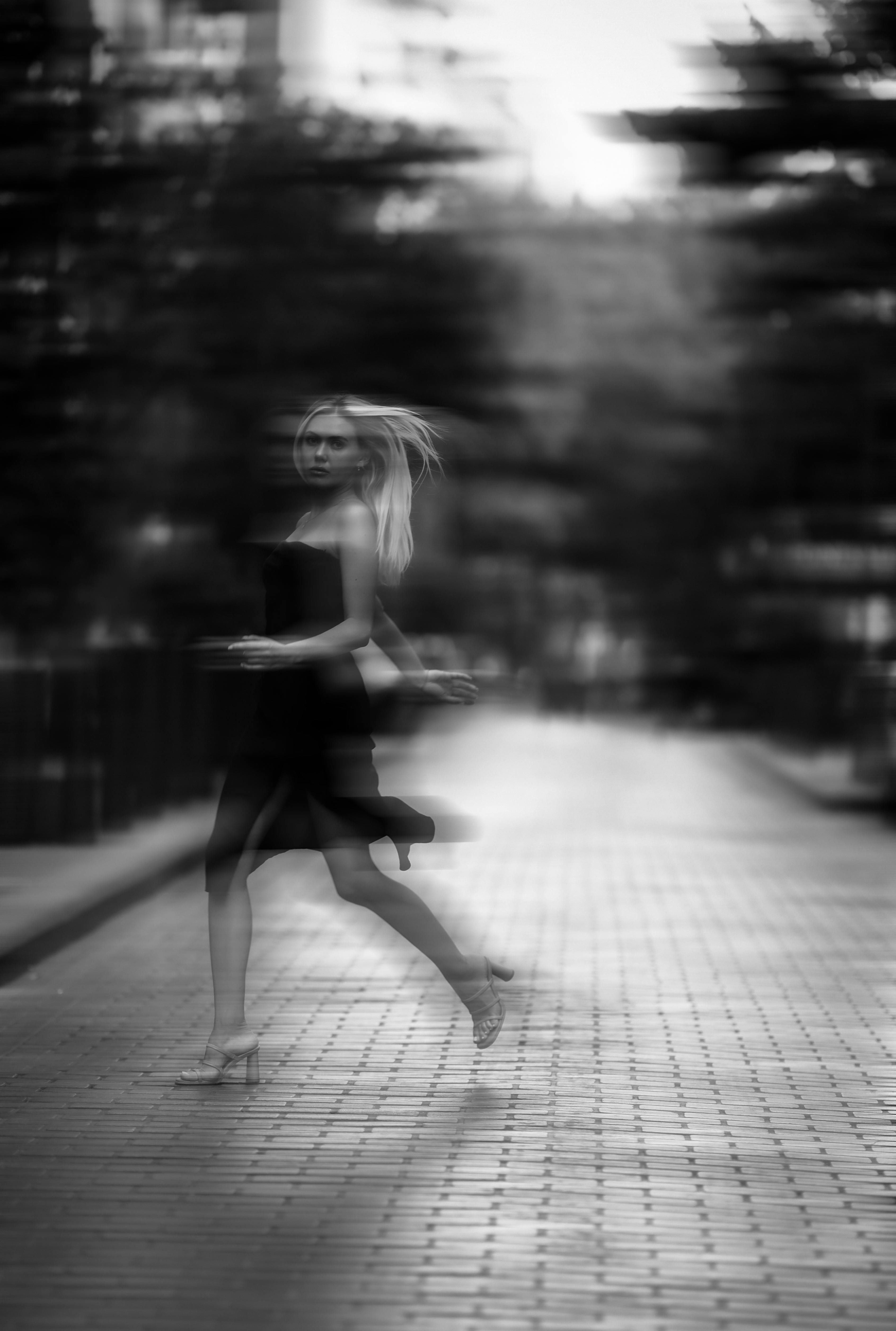 Blurry Photo of a Woman in a Dress Running on the Sidewalk · Free Stock ...