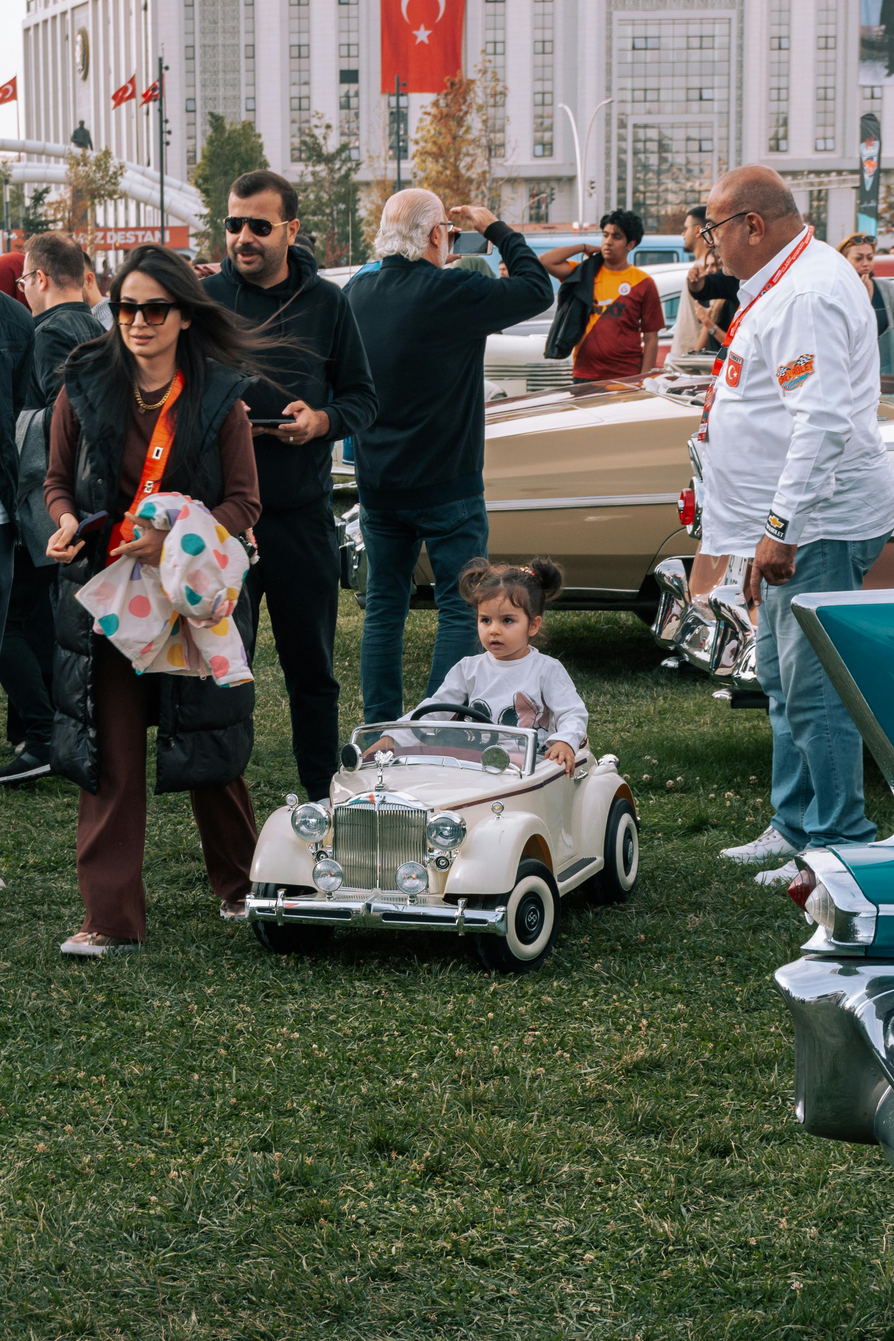 Little Girl Driving a Toy Car · Free Stock Photo