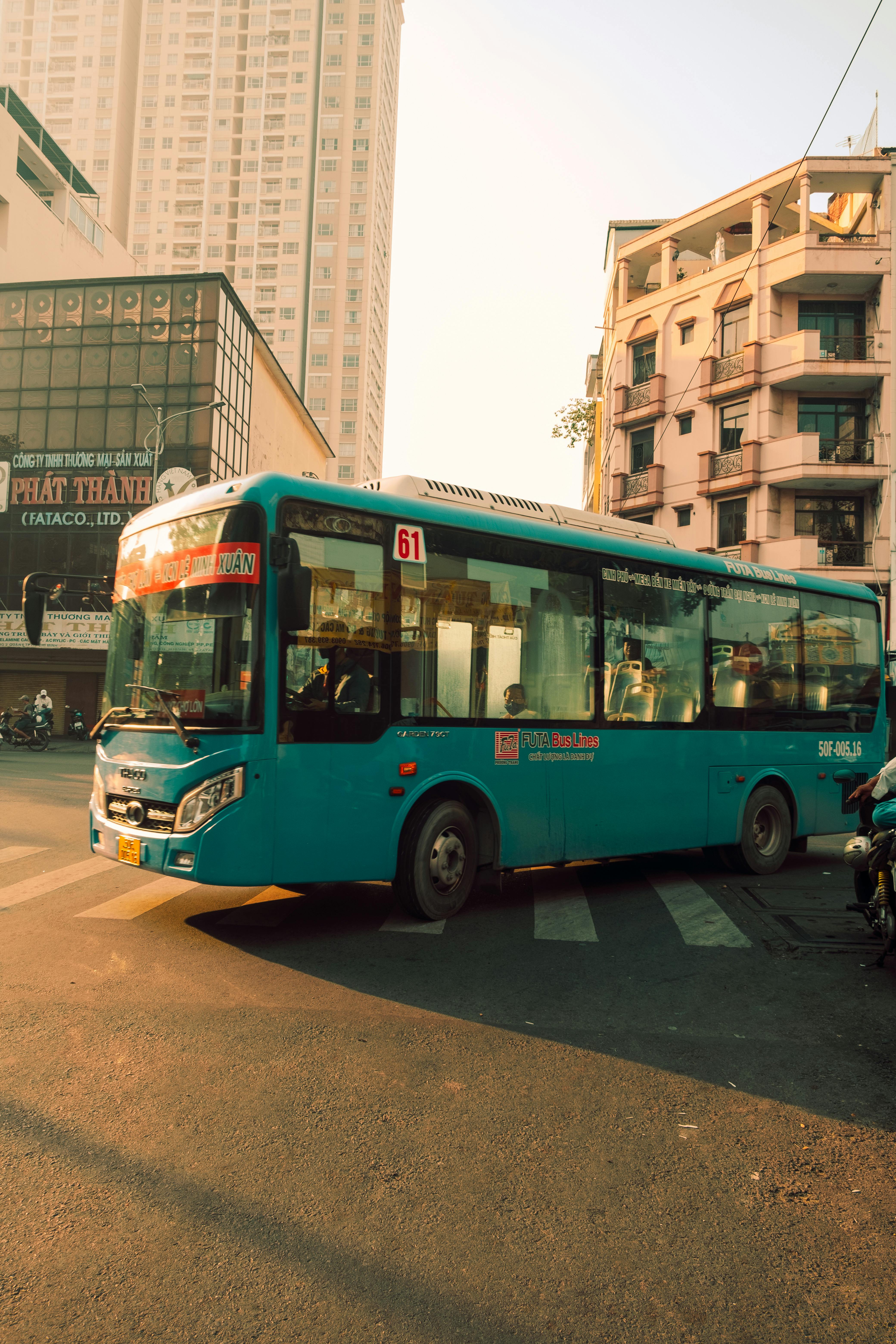 Blue Bus Turning on Street in City · Free Stock Photo