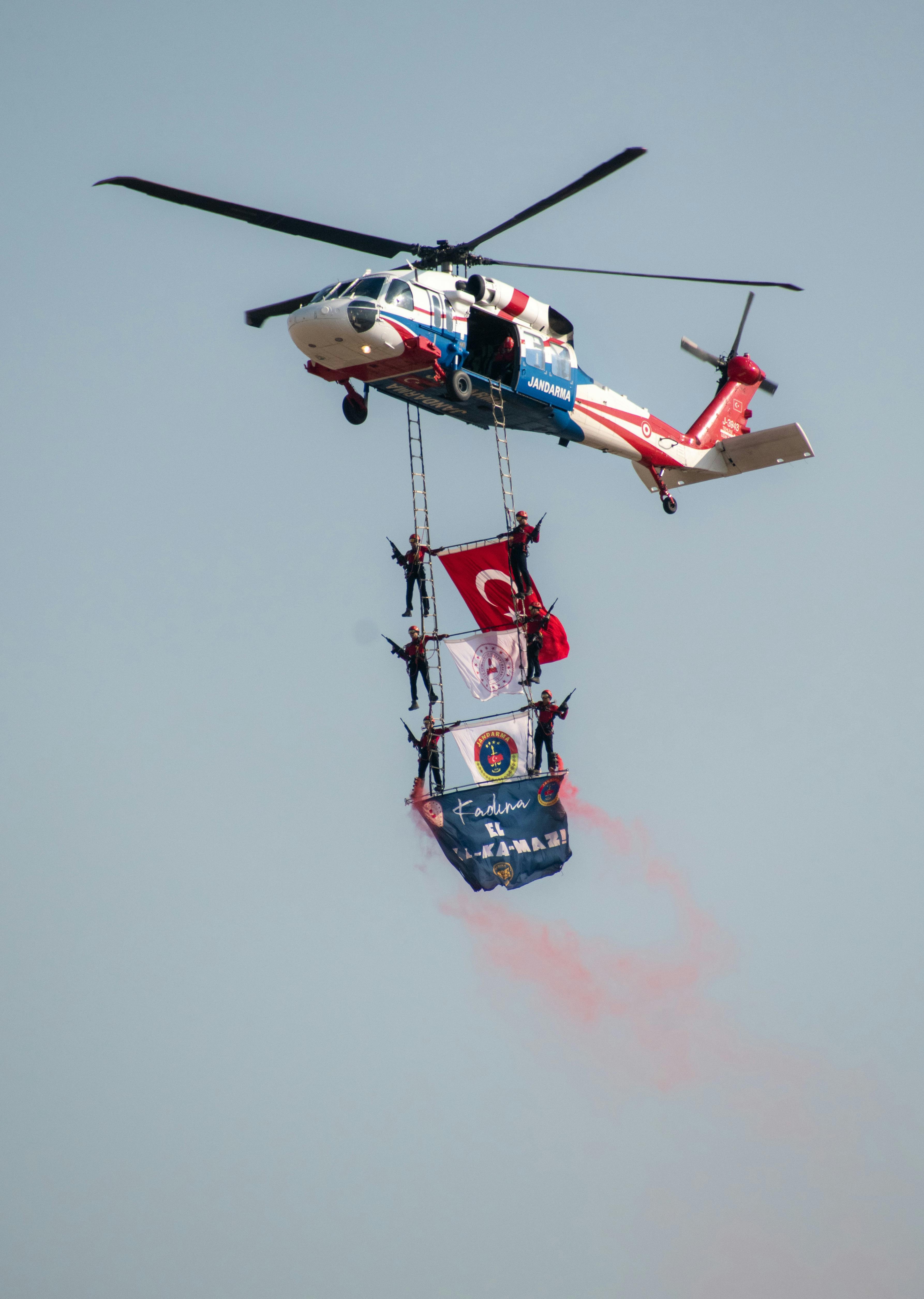 Soldiers with Flags under Flying Helicopter · Free Stock Photo