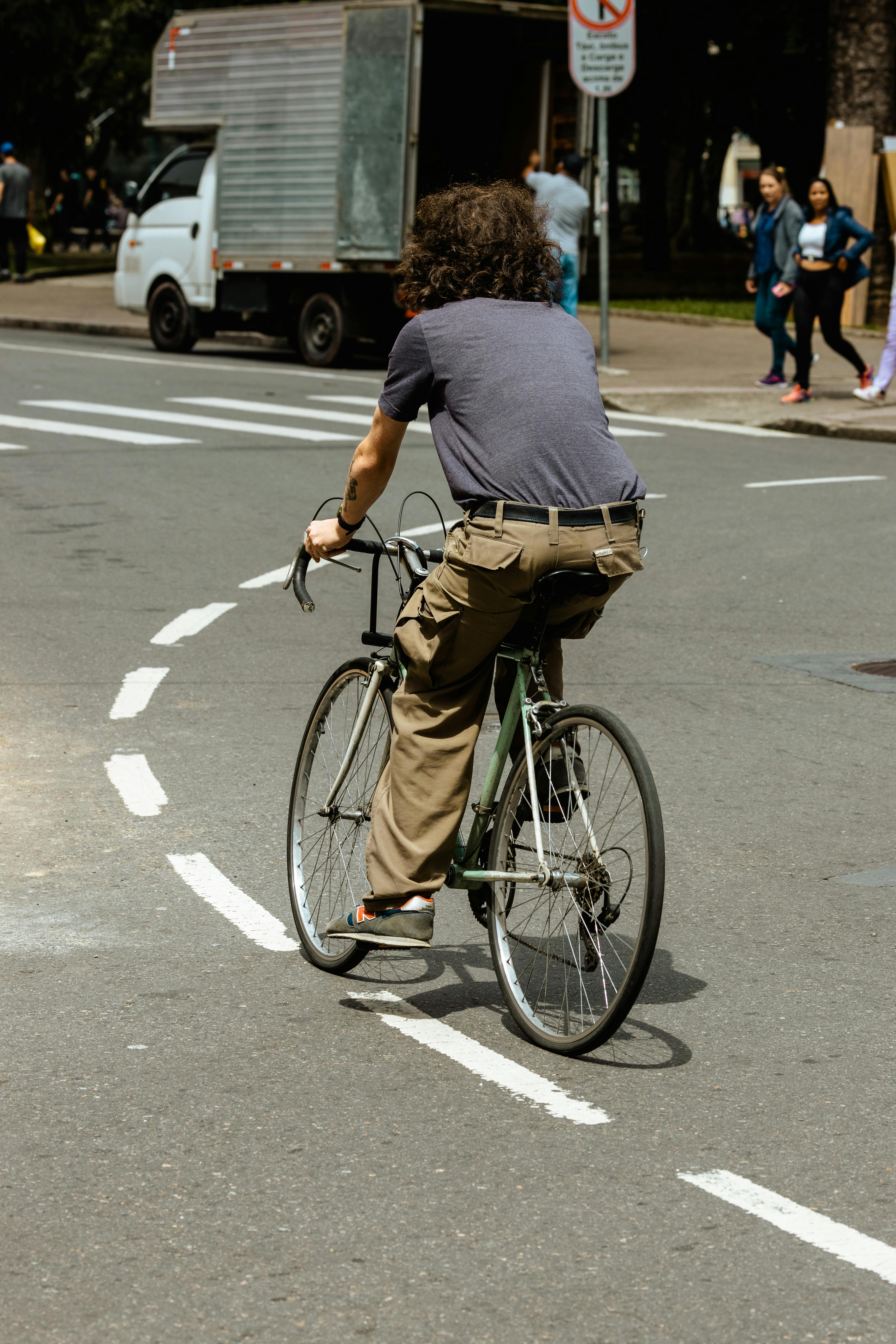 Man Riding a Bicycle on a Broken Line in the Street · Free Stock Photo