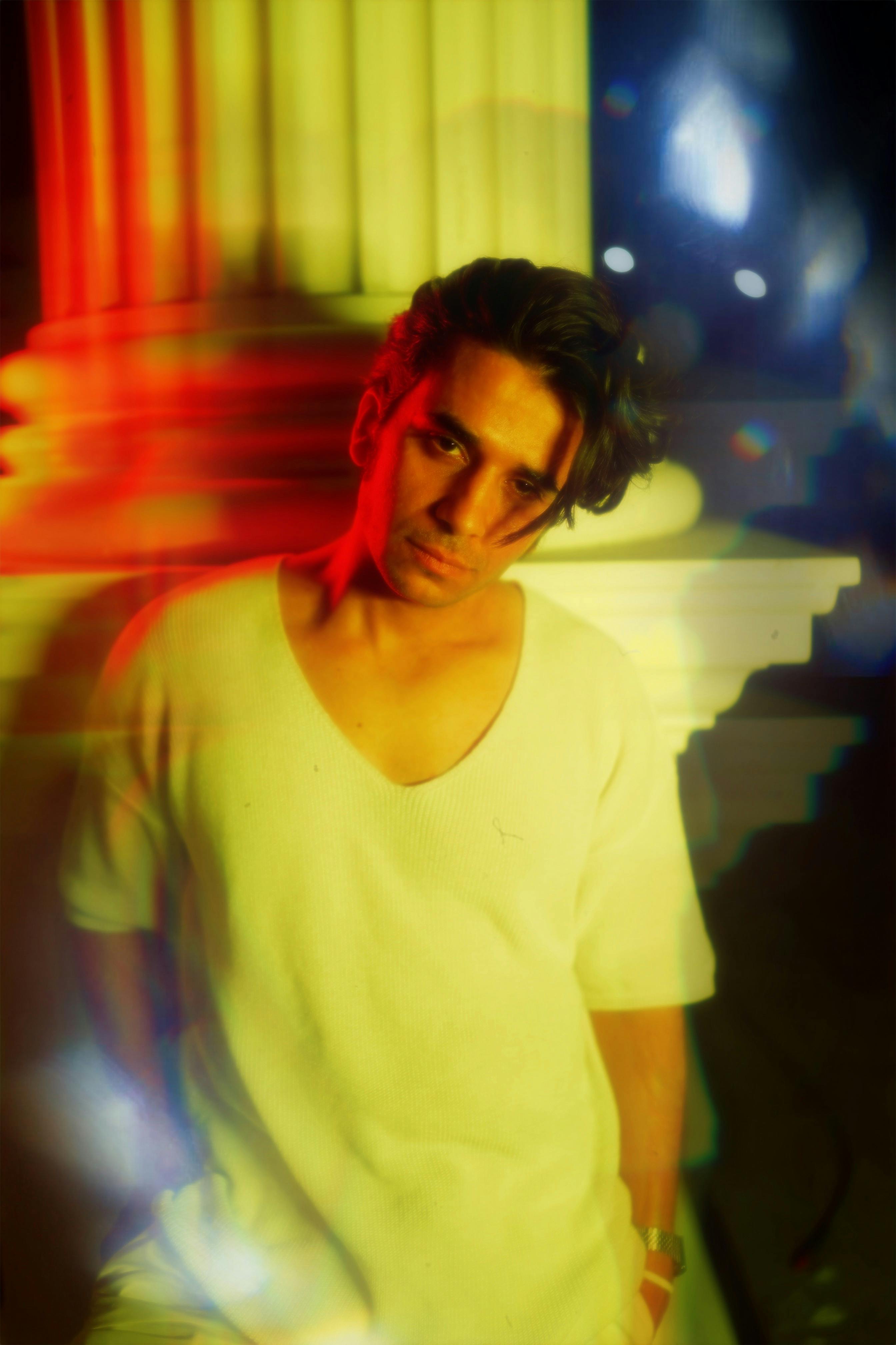 Handsome Man in Shirt and Jeans Sitting on Red Bench · Free Stock Photo