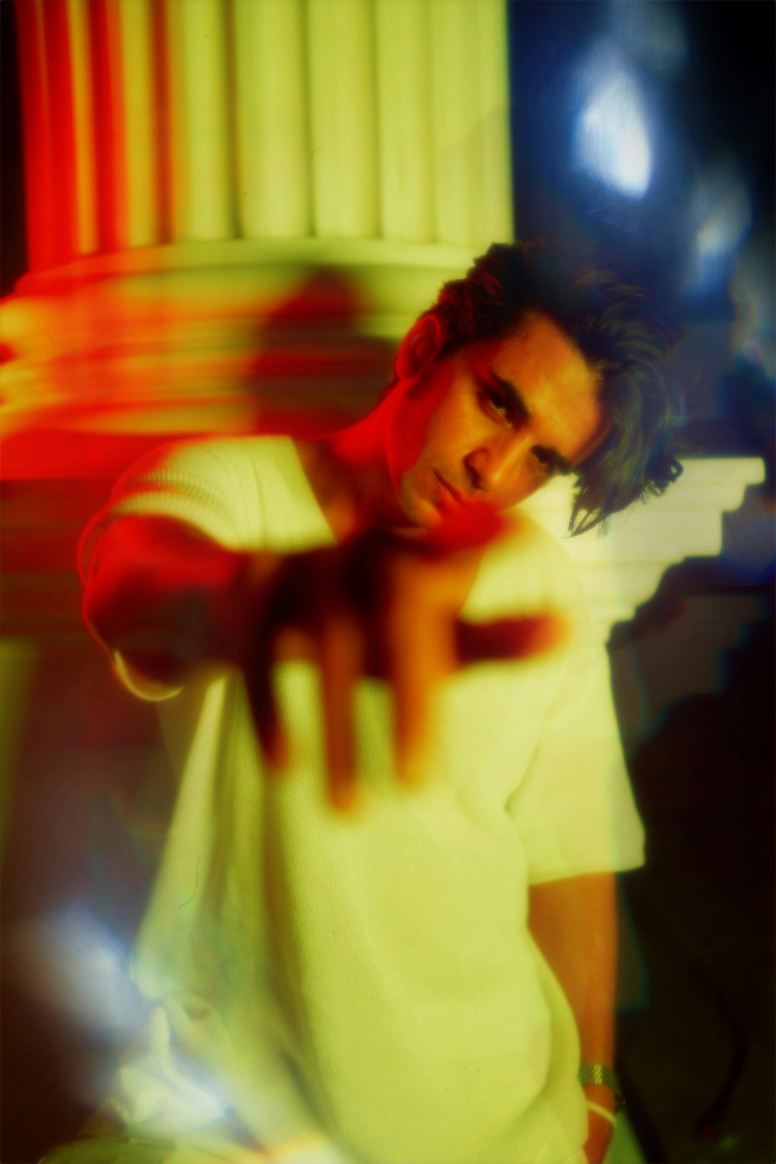 Pointing Man Leaning Against a Column · Free Stock Photo