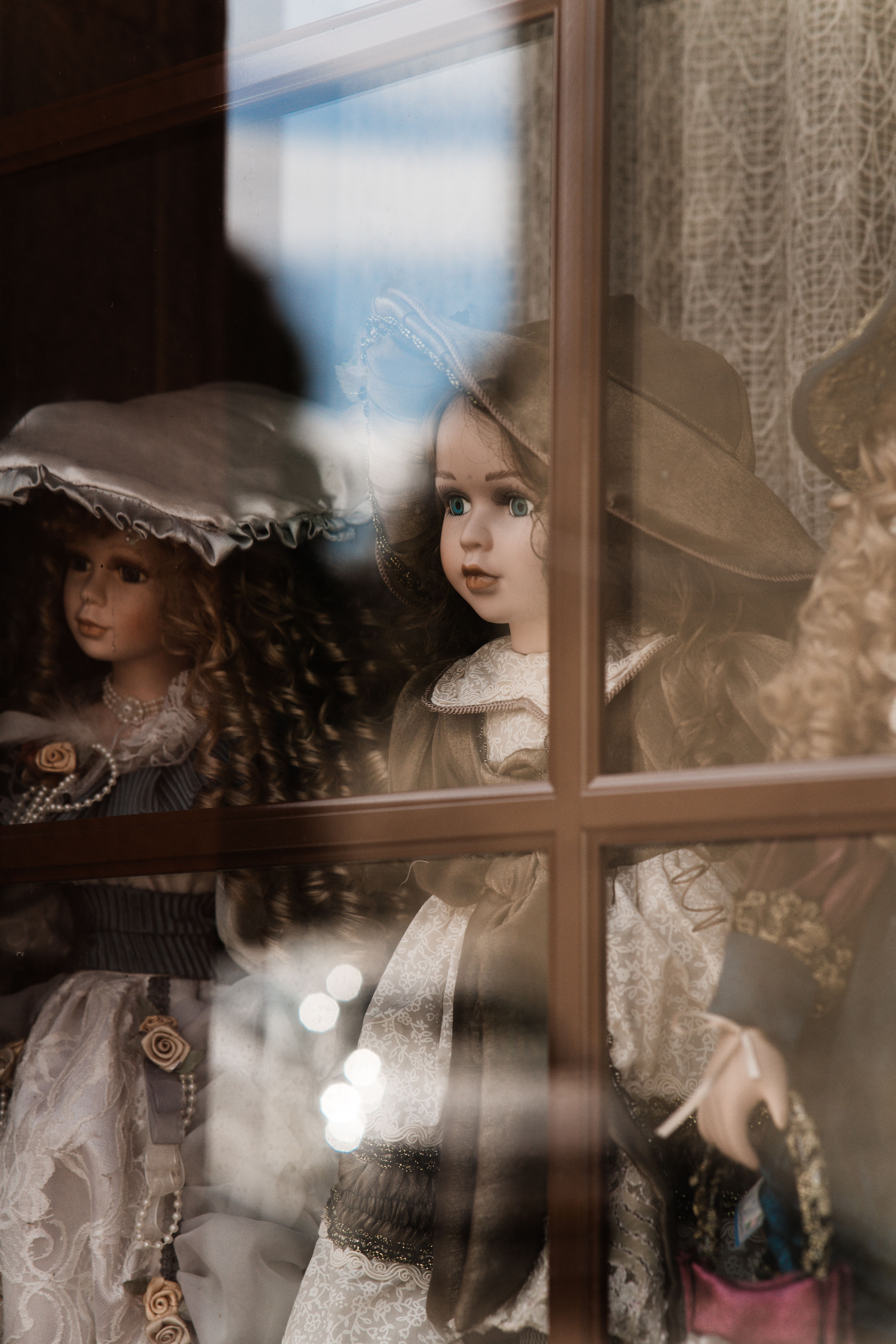 Antique Dolls behind a Window Glass · Free Stock Photo