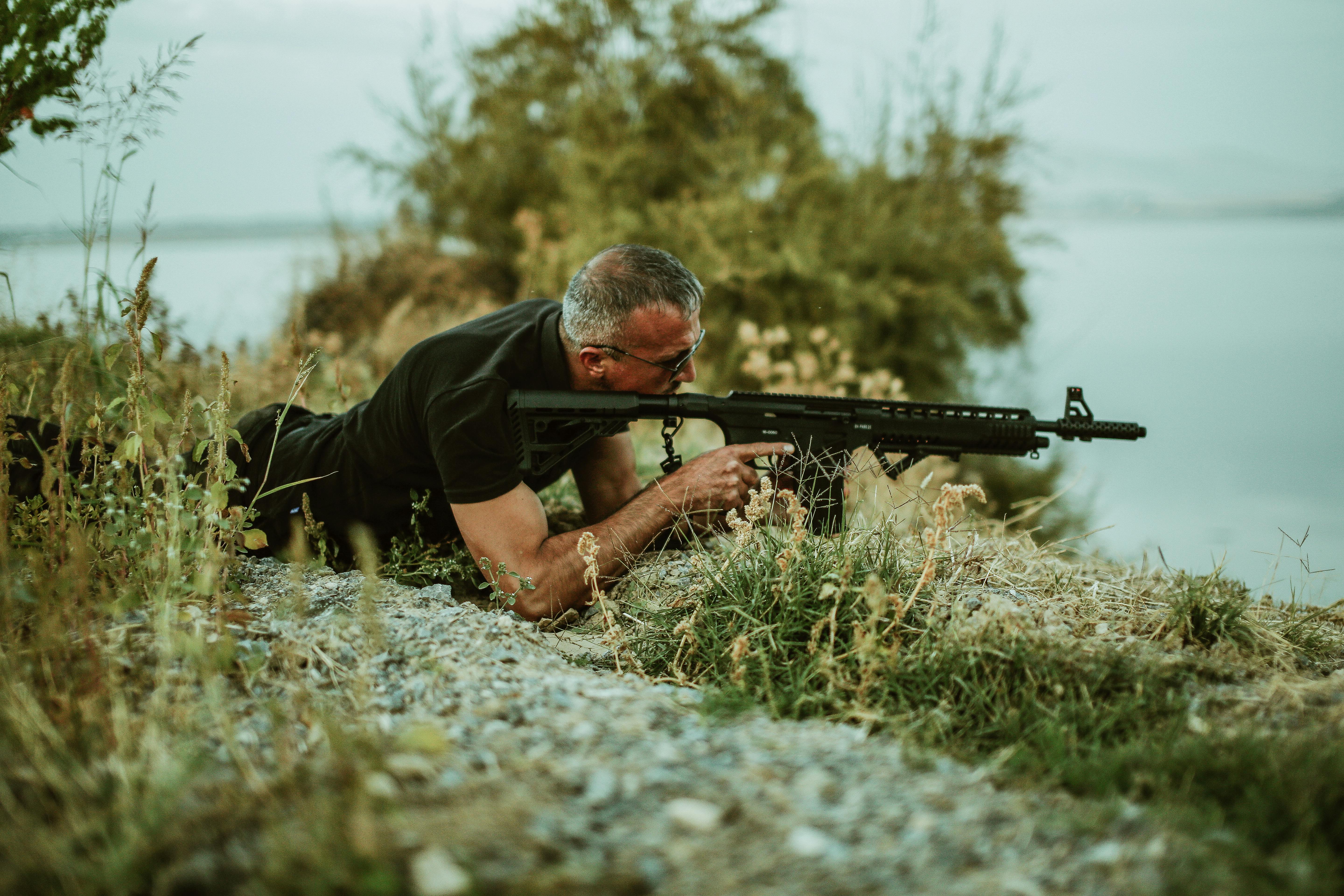Man shooting assult riffle in the wilderness · Free Stock Photo