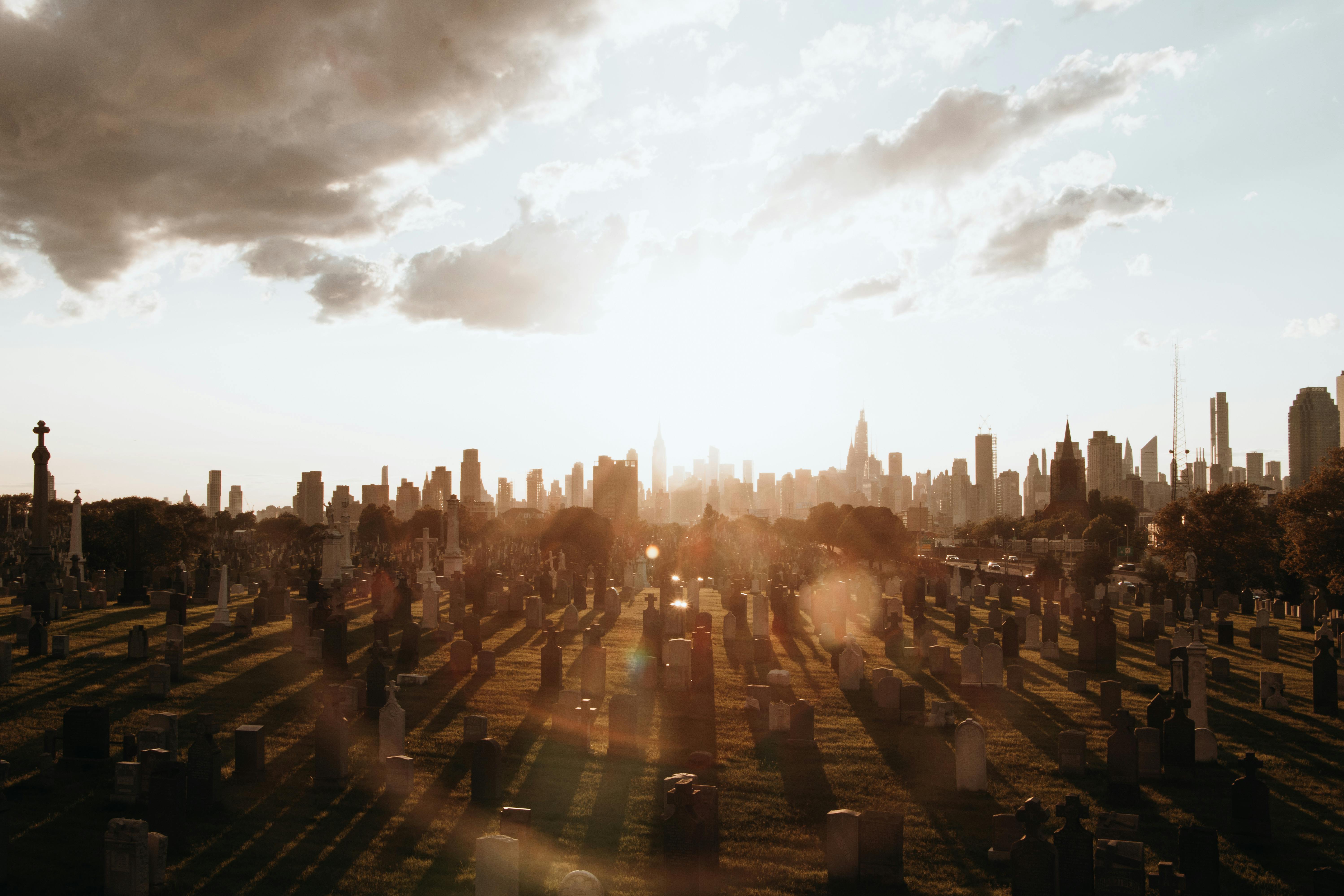 Graveyard in Light and Shadow, and a Cityscape in Background · Free ...