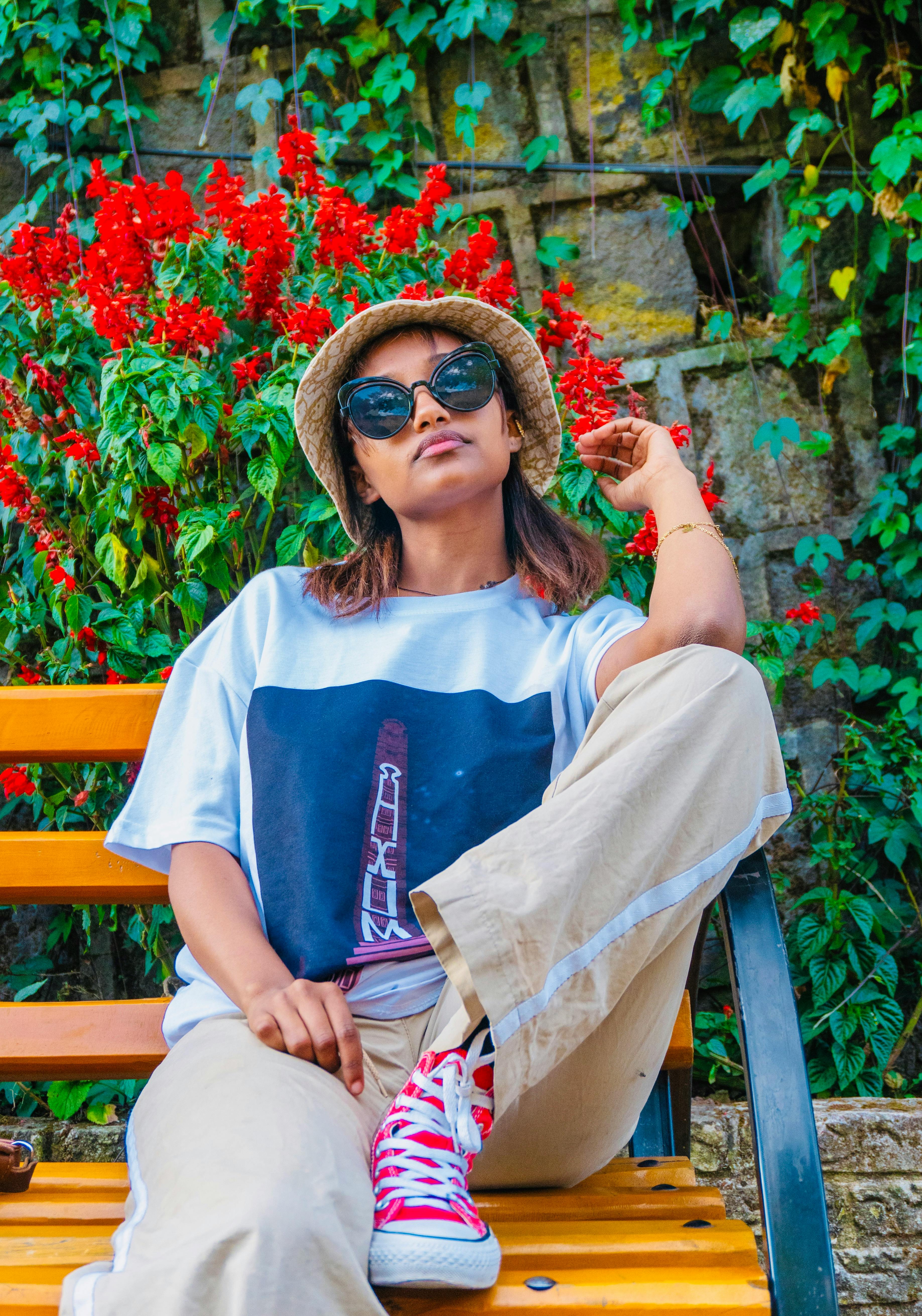 Brunette Woman with Bucket Hat Sitting with Drink in Hand · Free Stock ...
