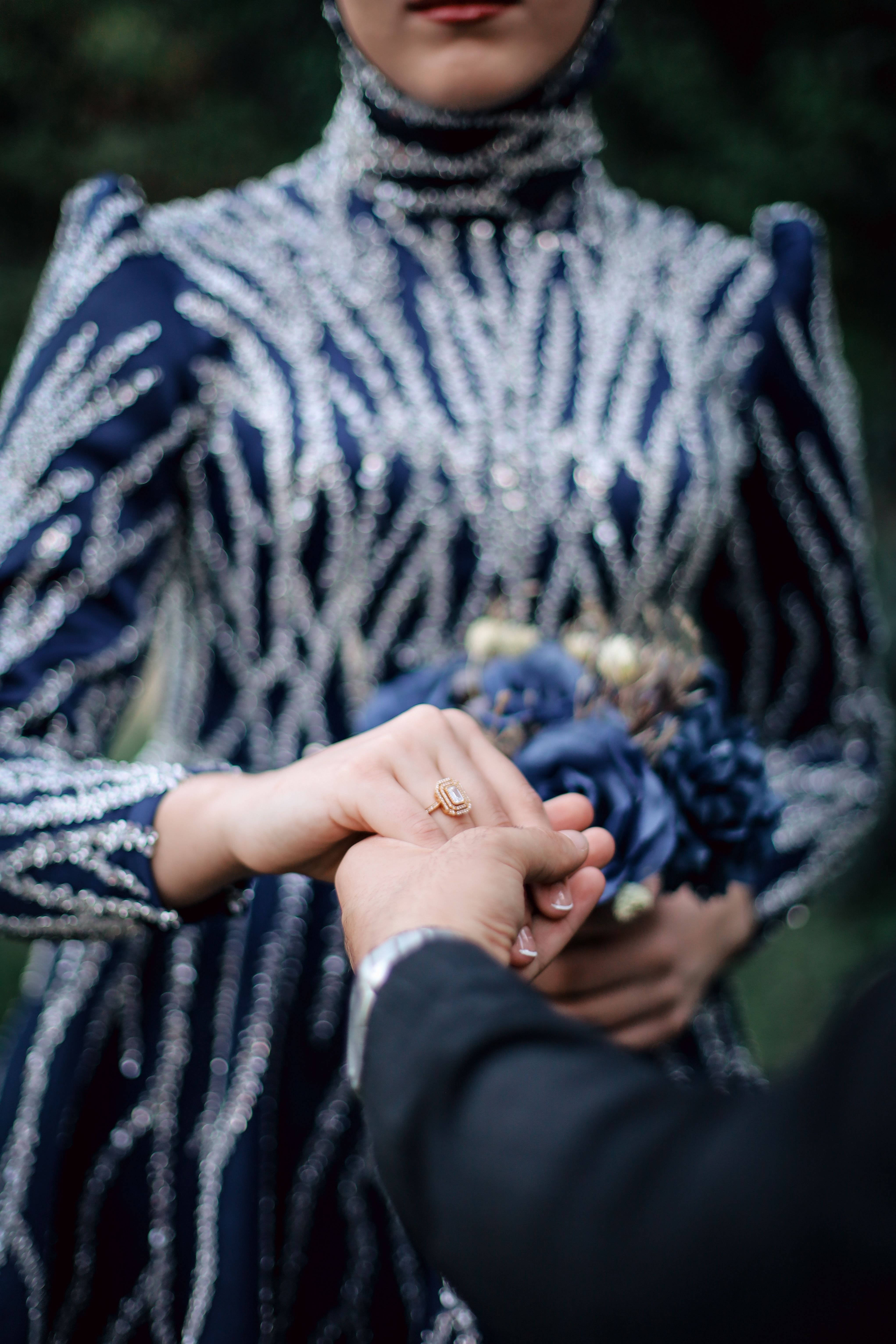 Engagement Ring on the Hand of a Woman in a Navy Blue Dress with Silver ...