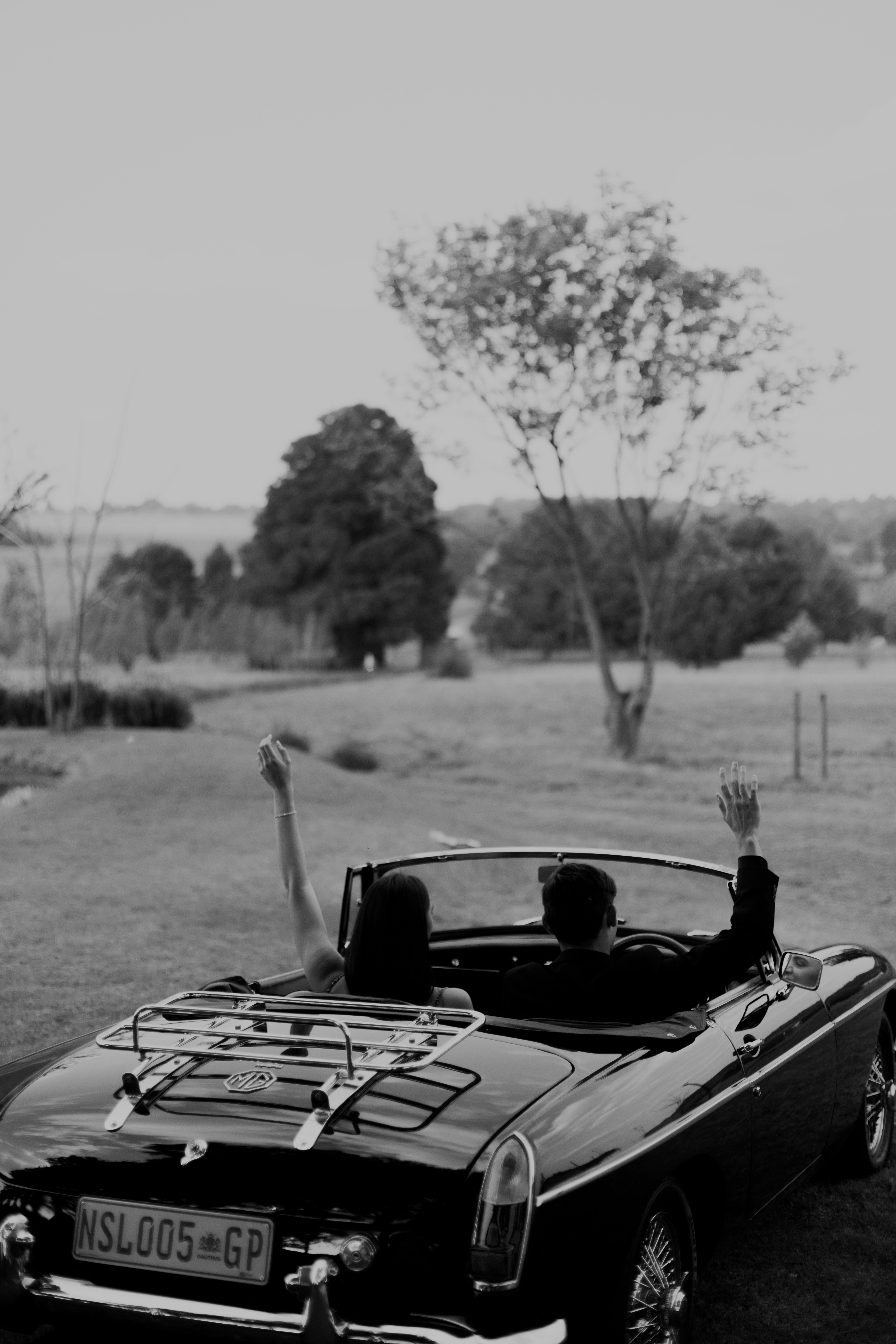 People Riding a Vintage Car in Black and White · Free Stock Photo