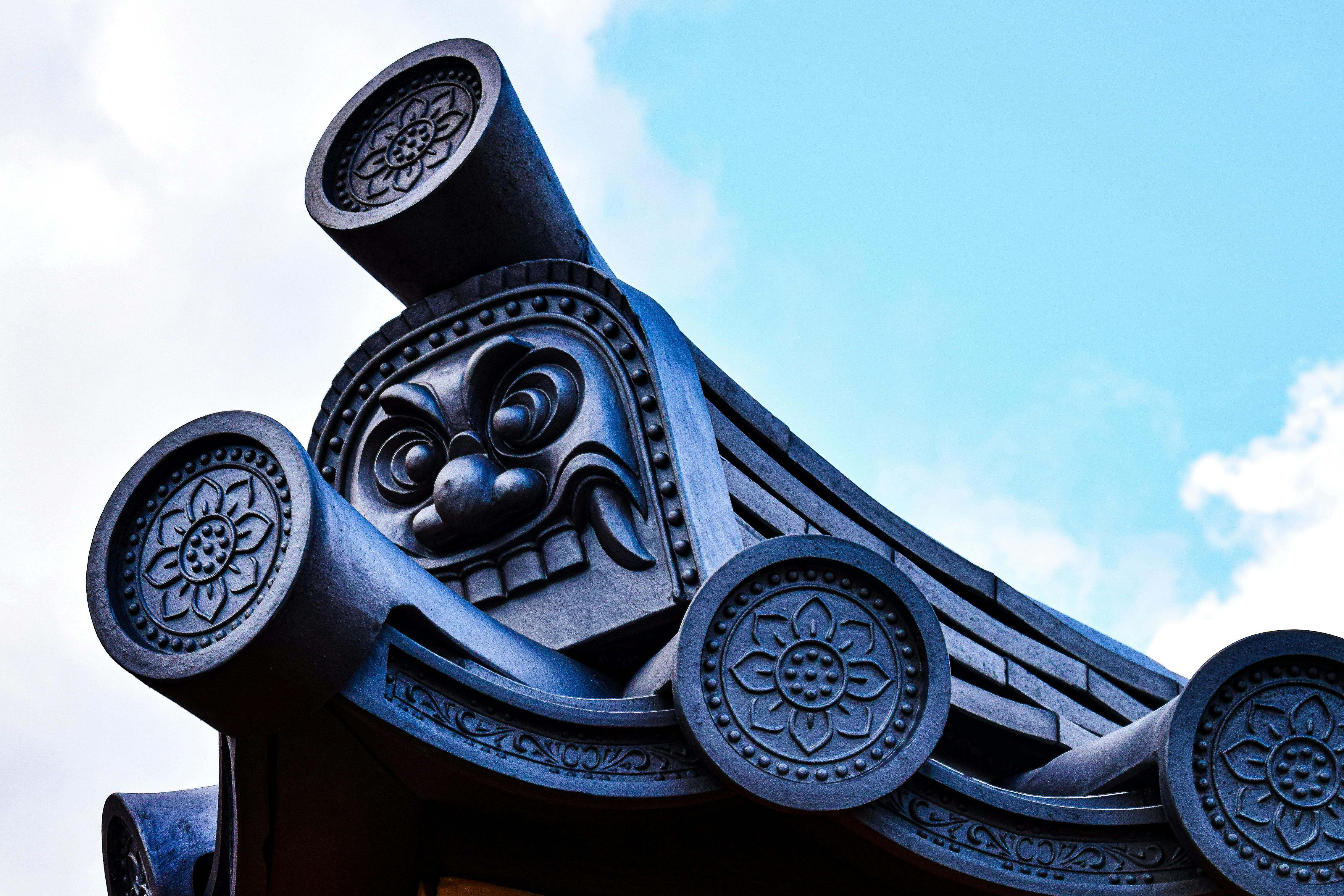 A close up of a japanese roof with a blue sky · Free Stock Photo