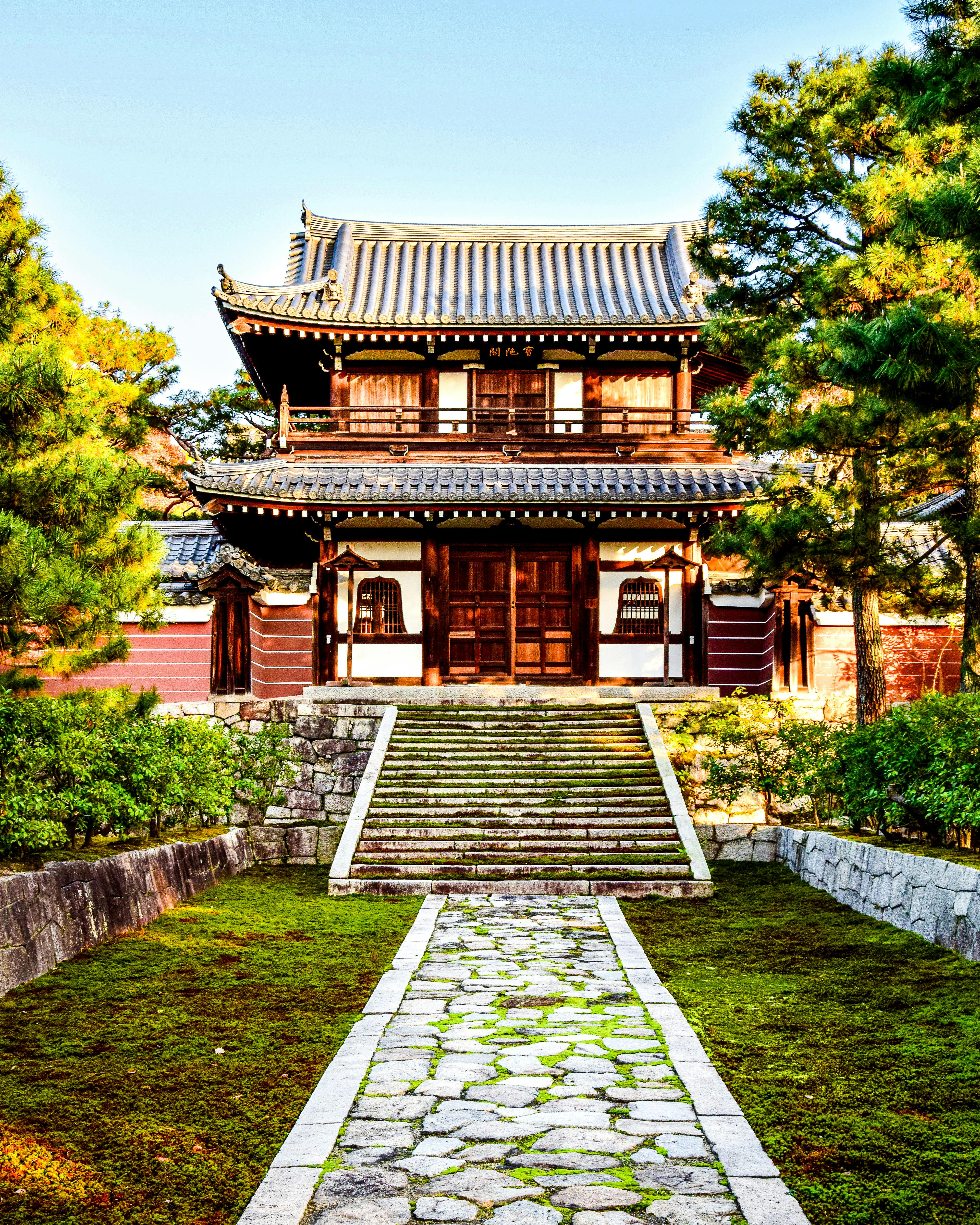 A japanese style building with a stone path · Free Stock Photo