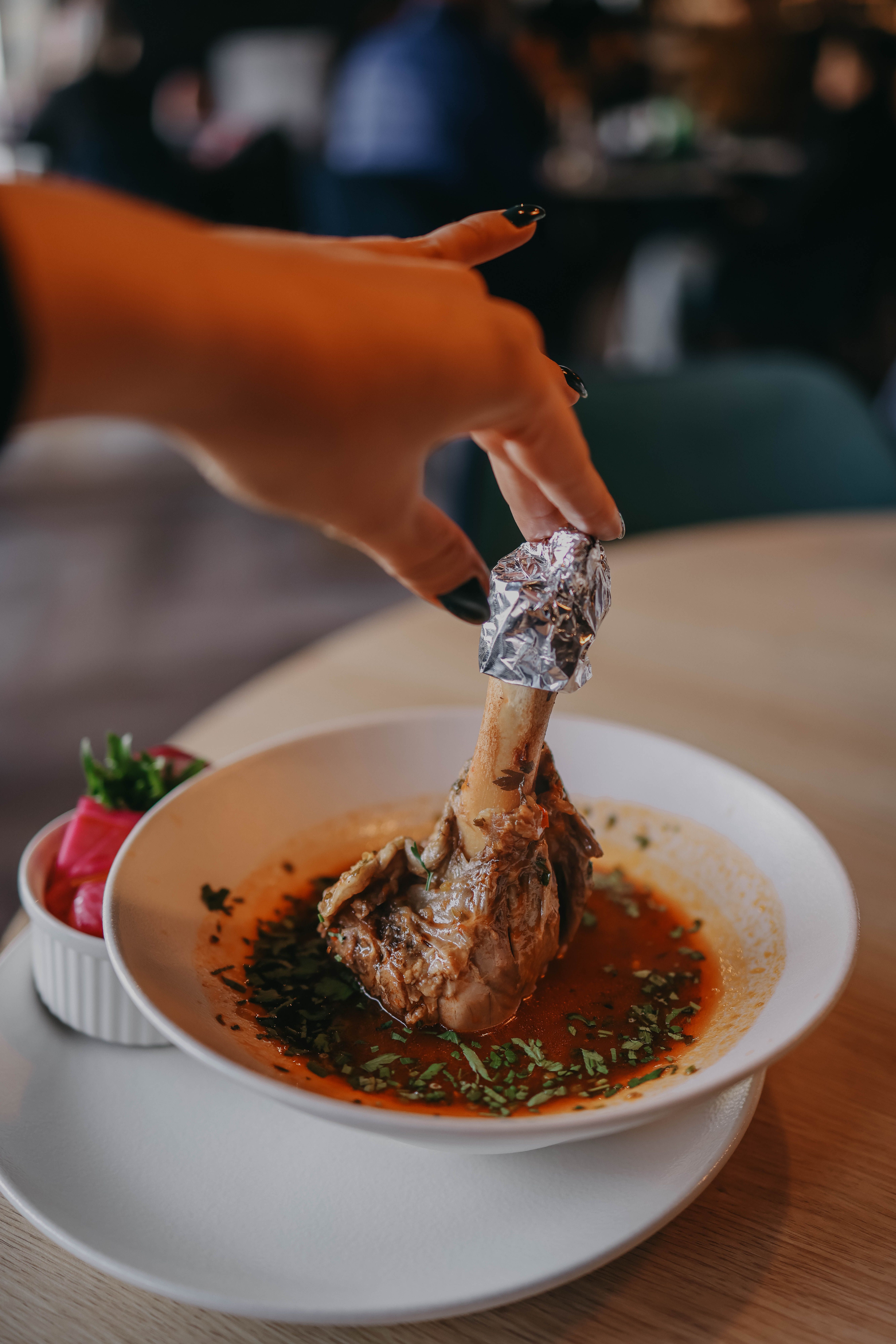 Womans Hand Holding a Piece of Lamb Meat · Free Stock Photo