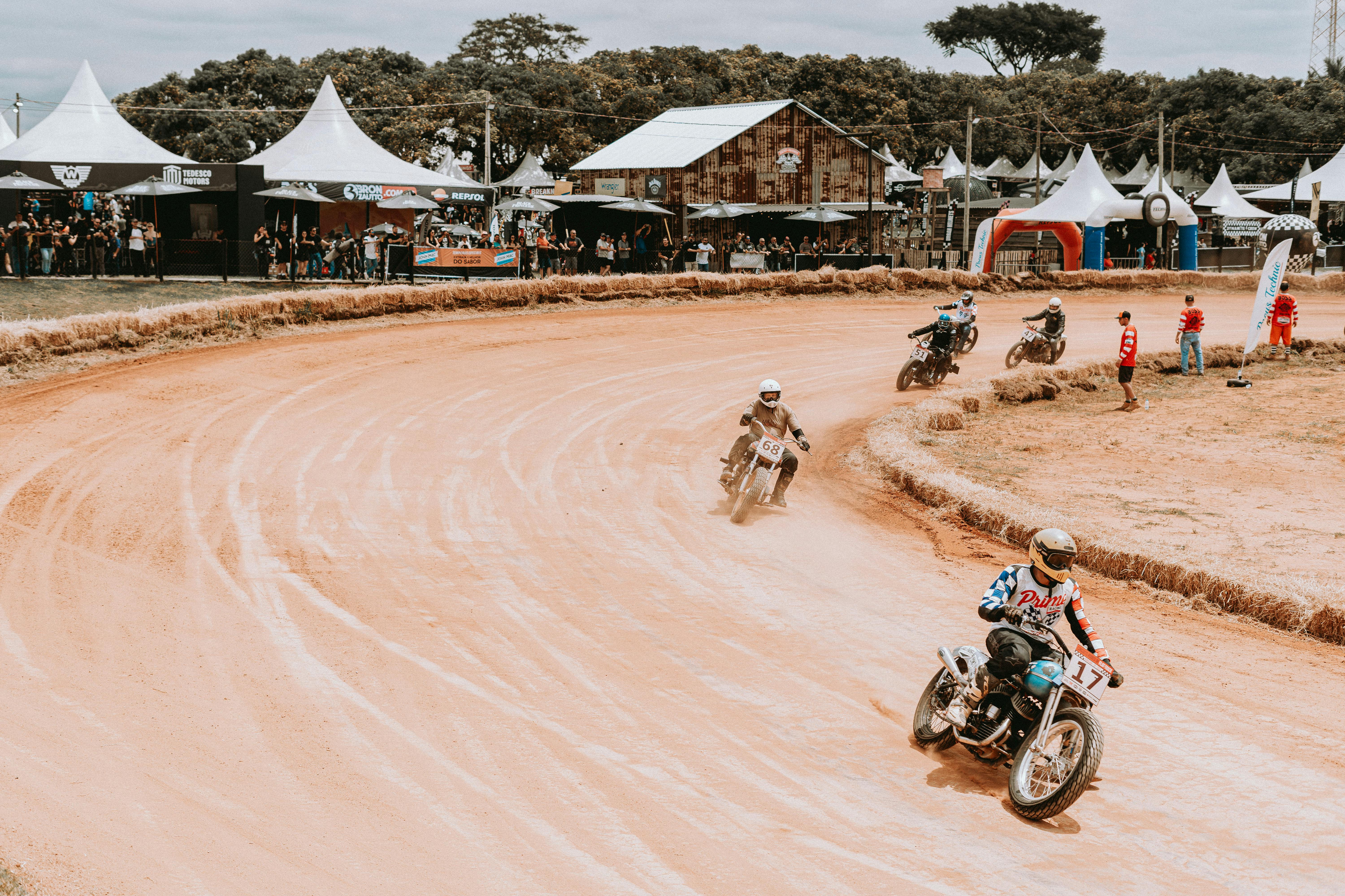 Riders on Motorcycles Racing on Sandy Track · Free Stock Photo