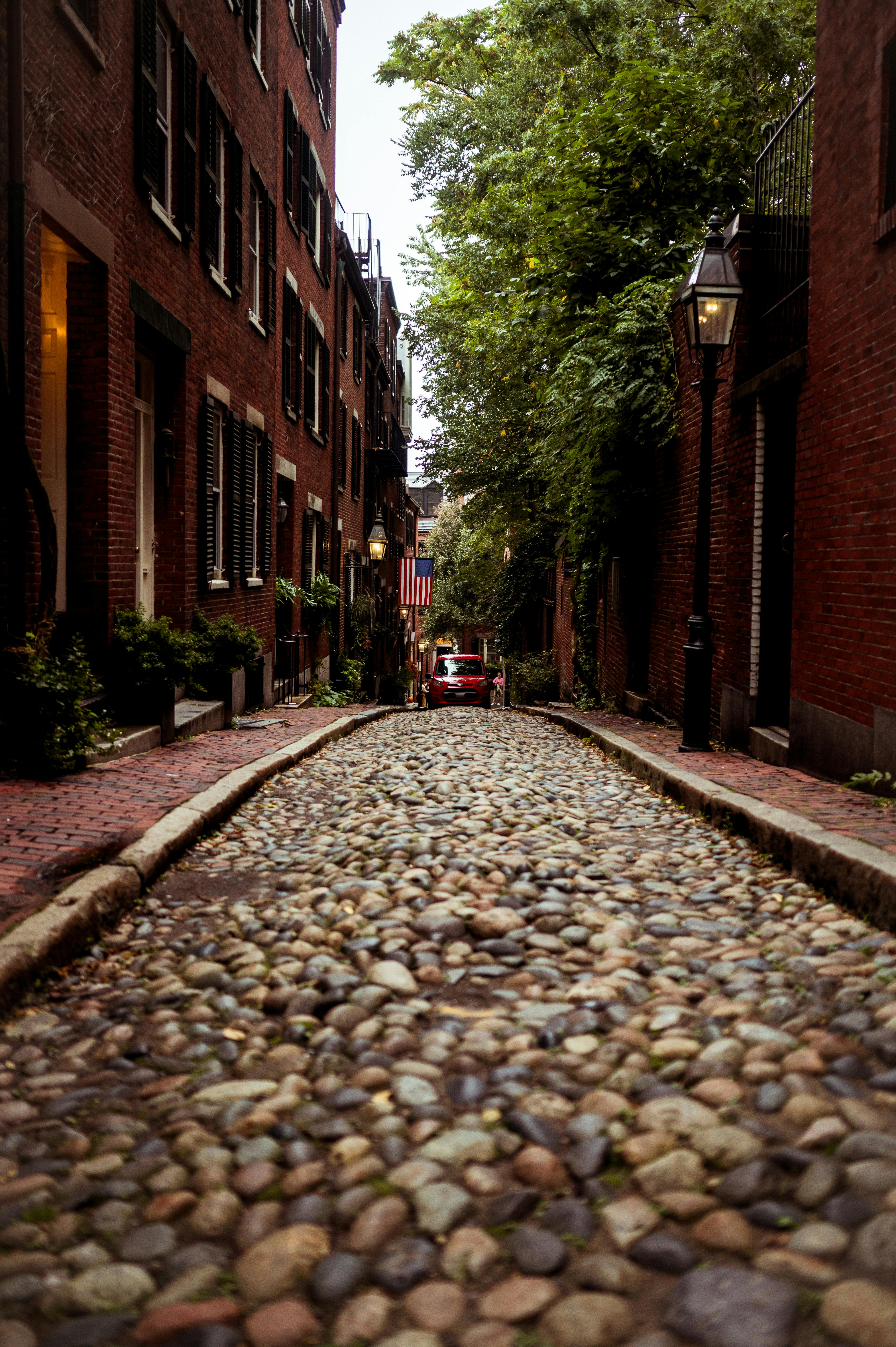 Car Running on Cobblestone Street · Free Stock Photo