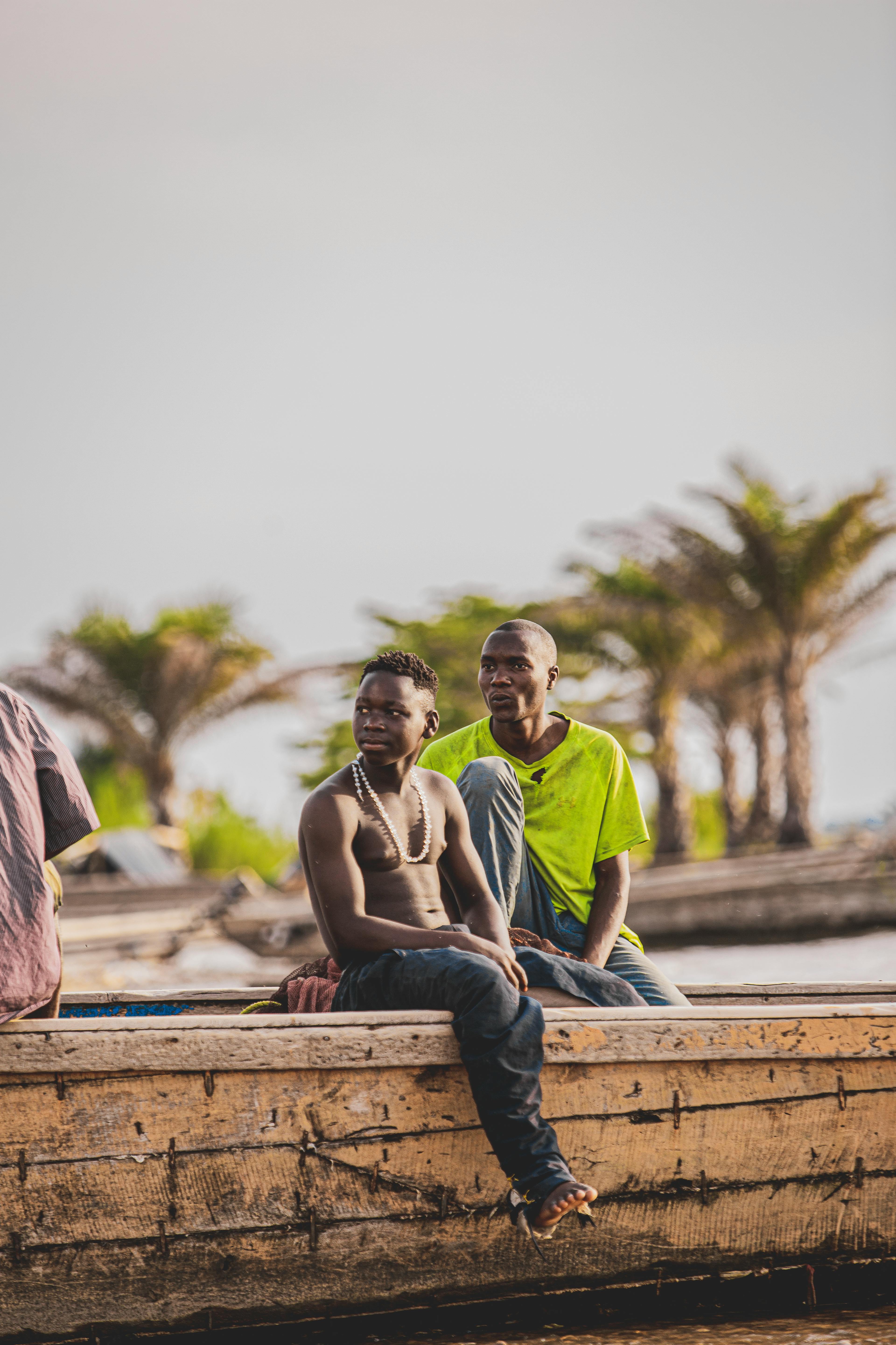 African Men Sitting on Wall · Free Stock Photo
