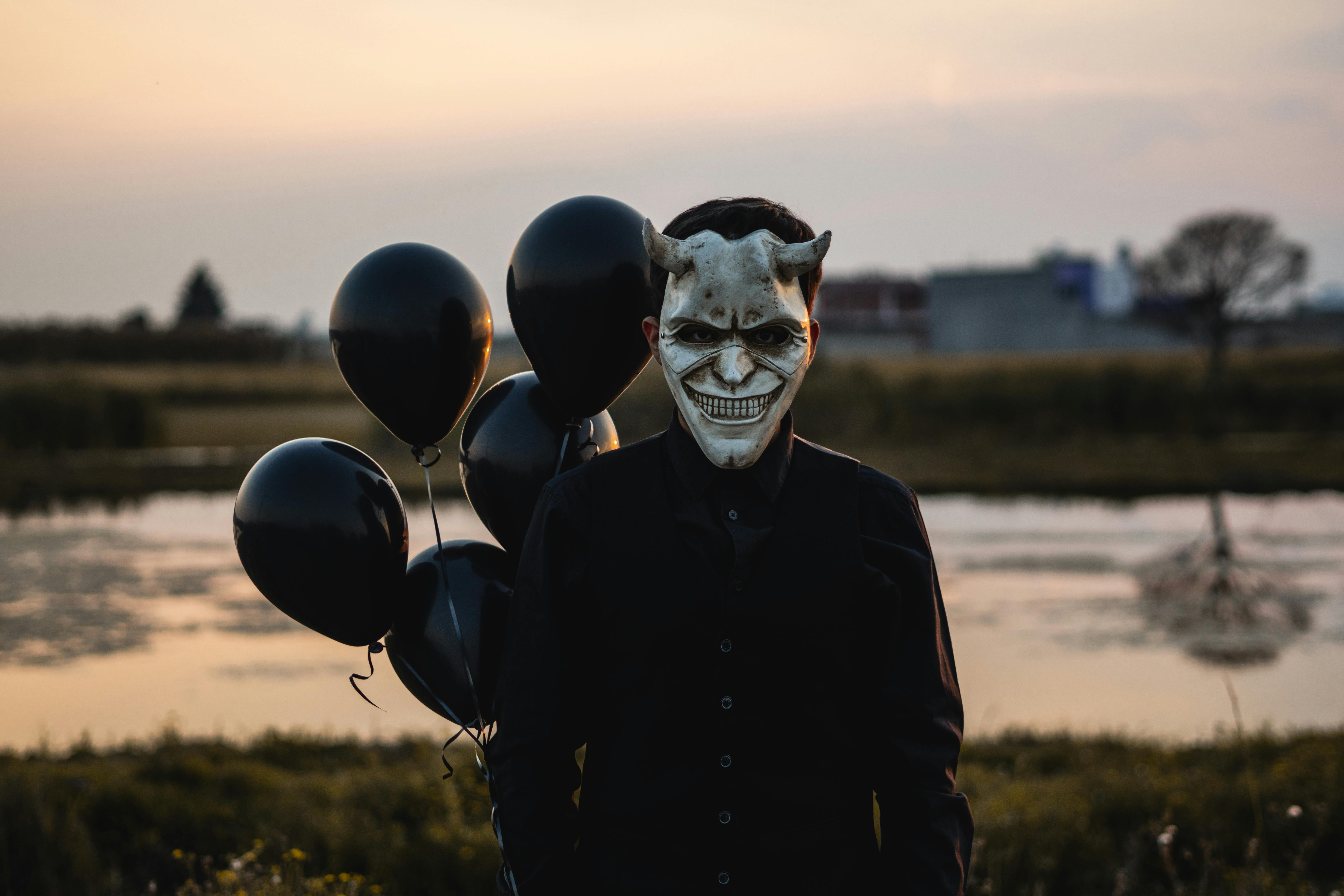 Man Wearing Devil Mask by the Lake · Free Stock Photo