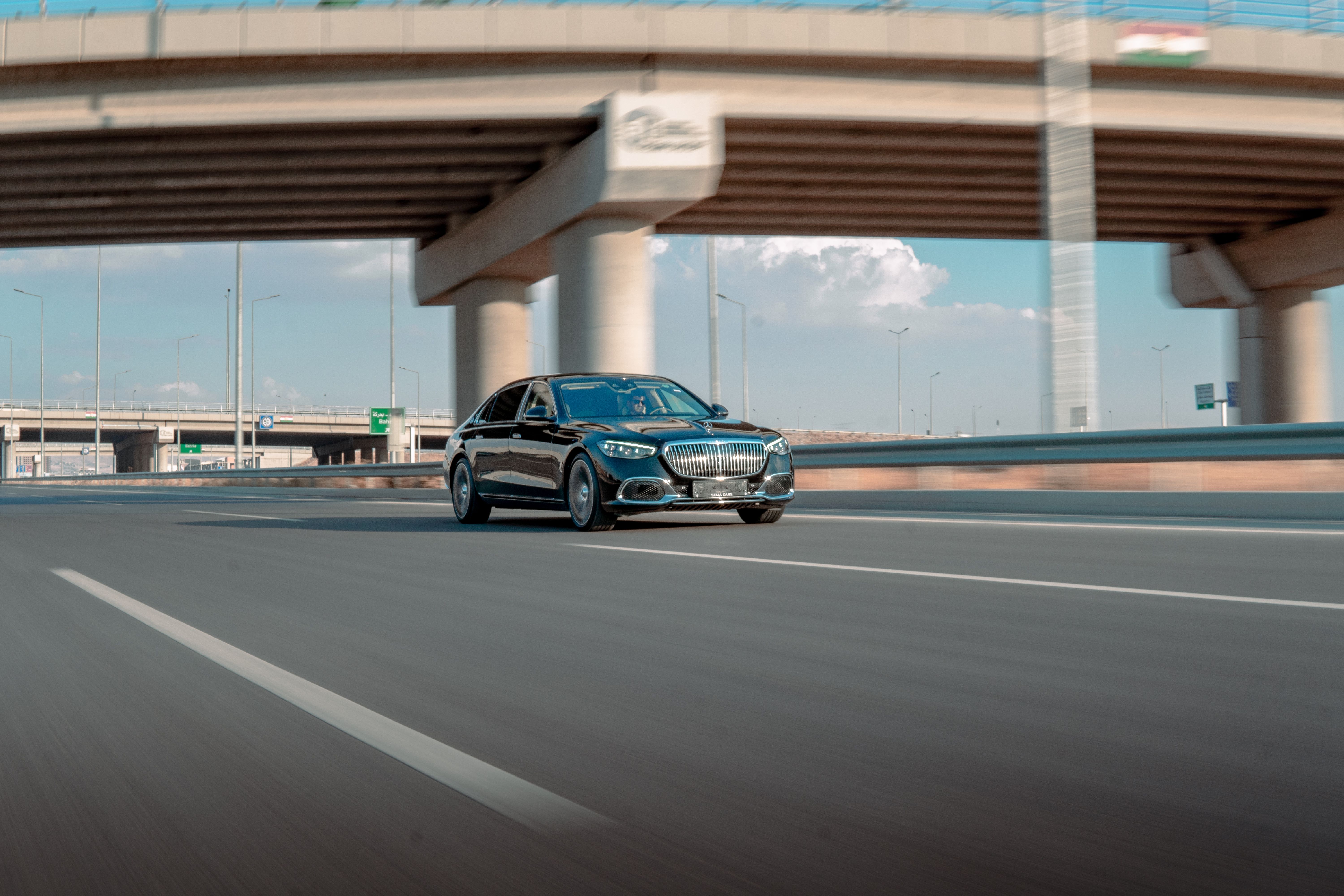 A car driving on the highway under an overpass · Free Stock Photo