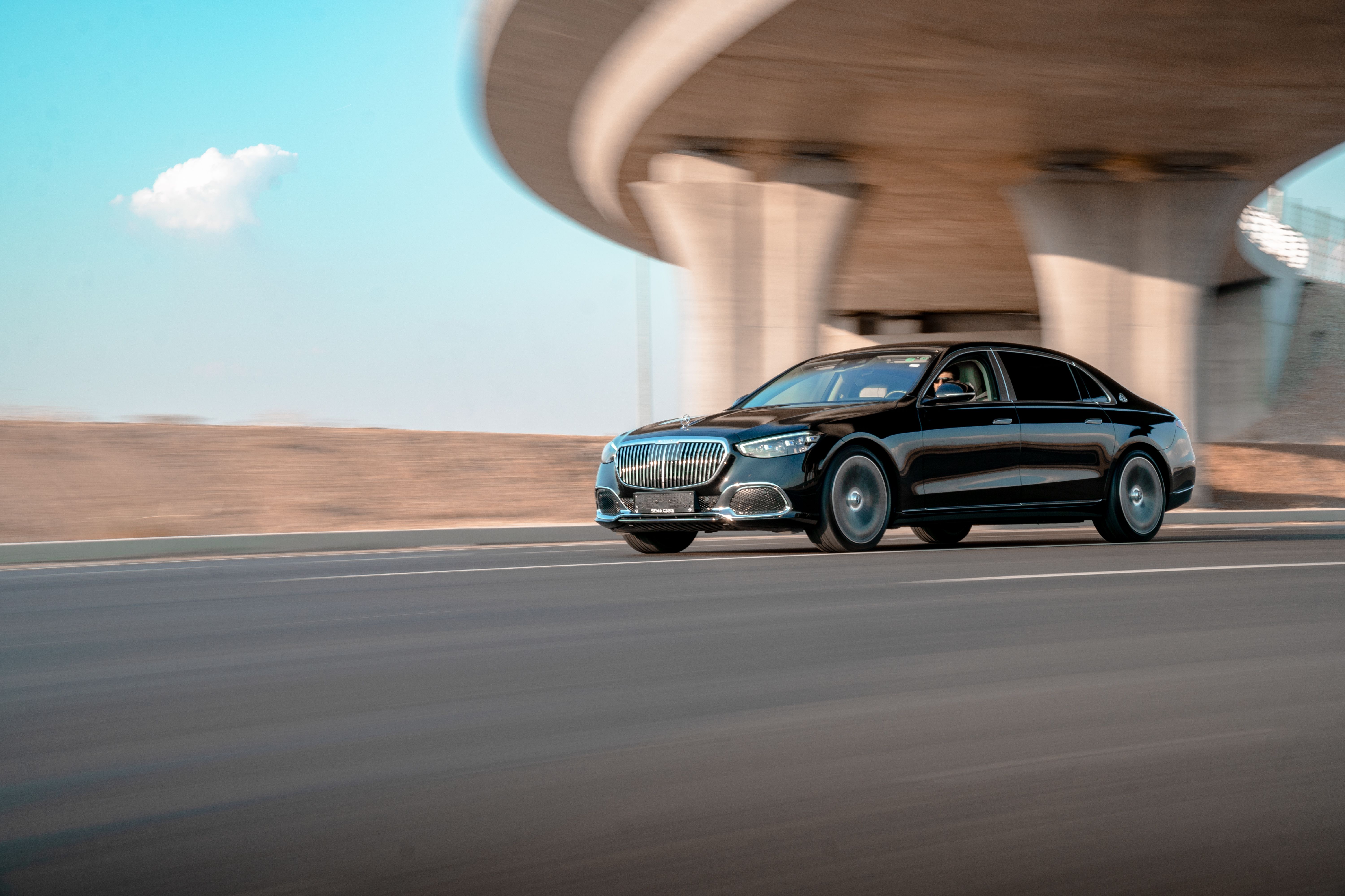 Luxury Sedan on Highway with Modern Overpass · Free Stock Photo