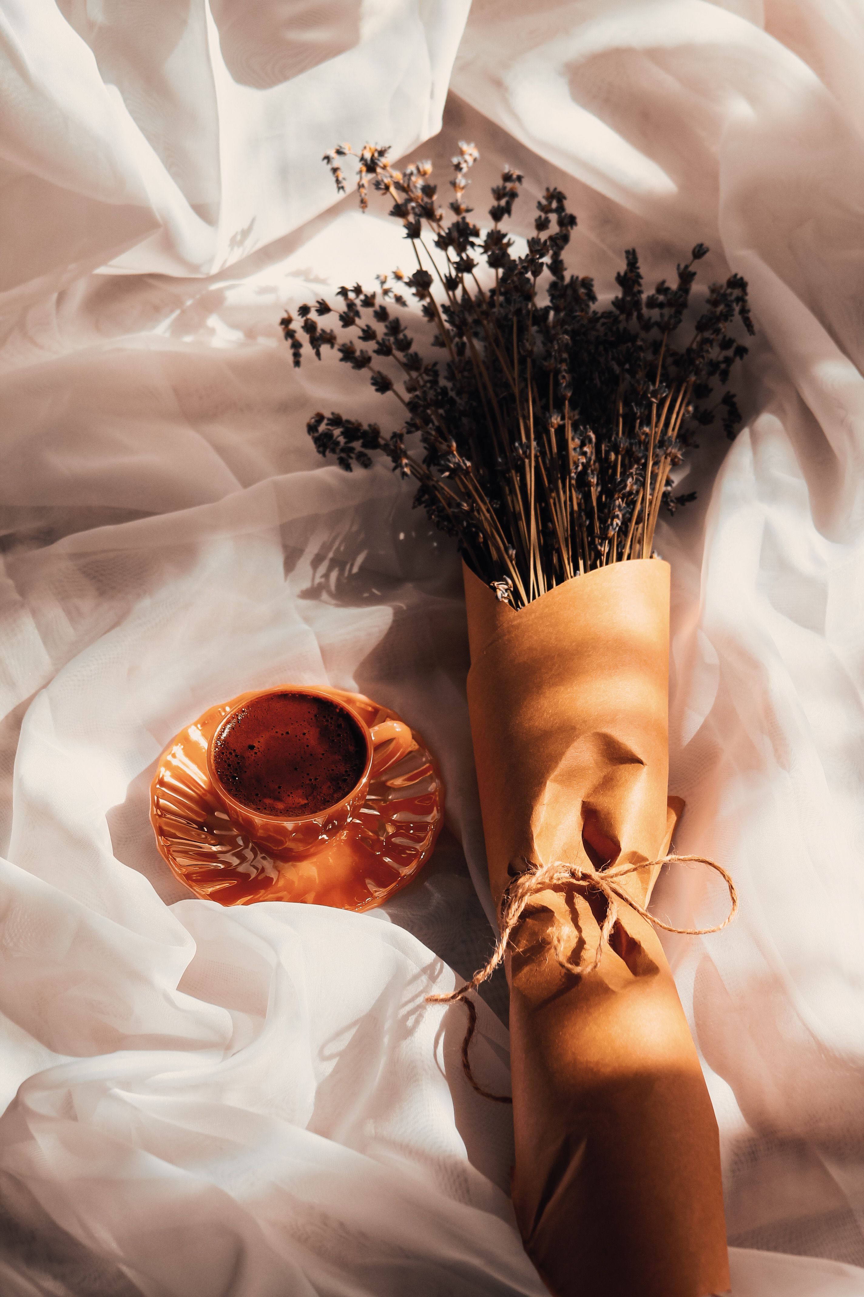 Brown Cup of Coffee Next to a Bouquet of Dried Flowers · Free Stock Photo