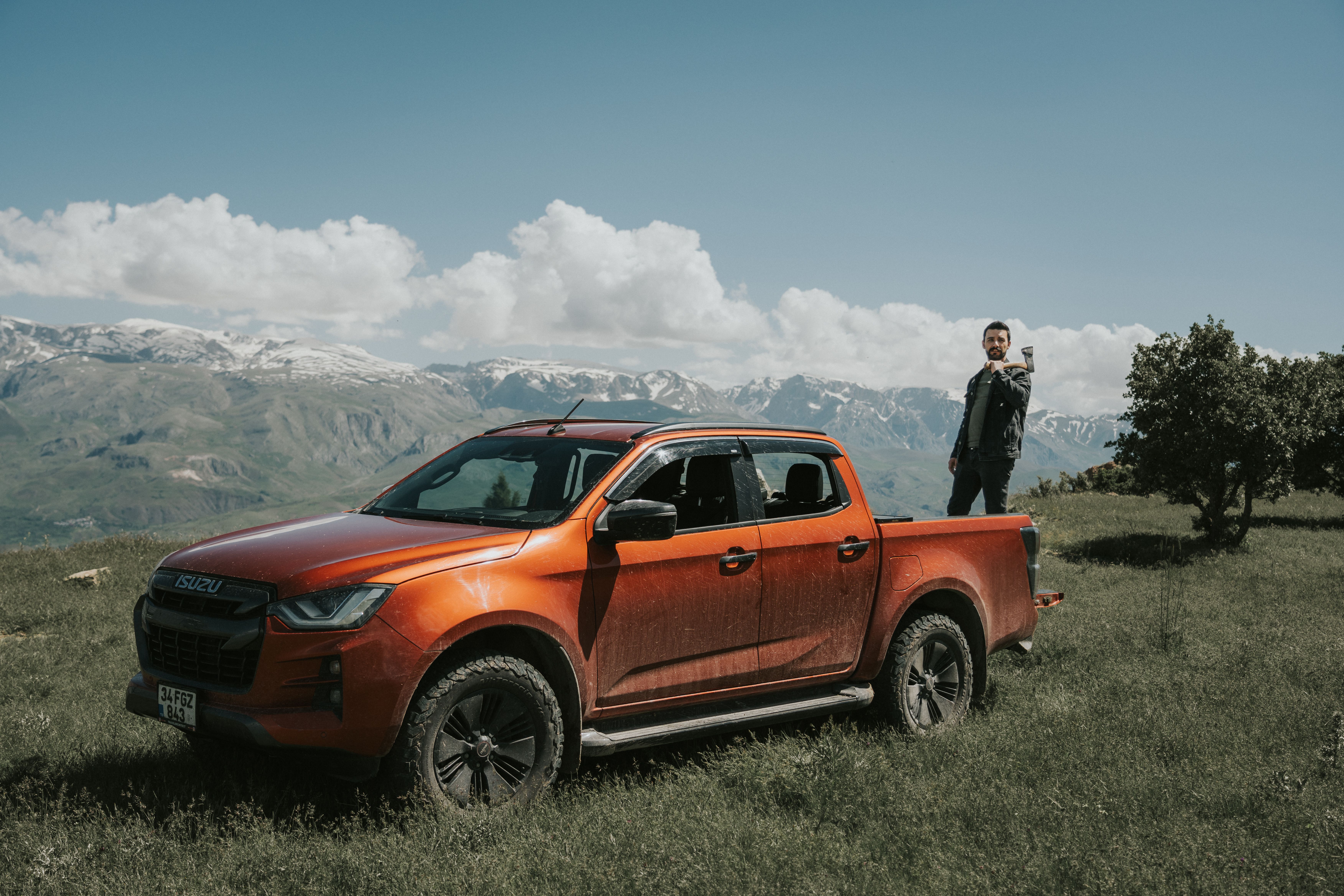 Photo of a Man Standing on a Vehicle with an Axe · Free Stock Photo