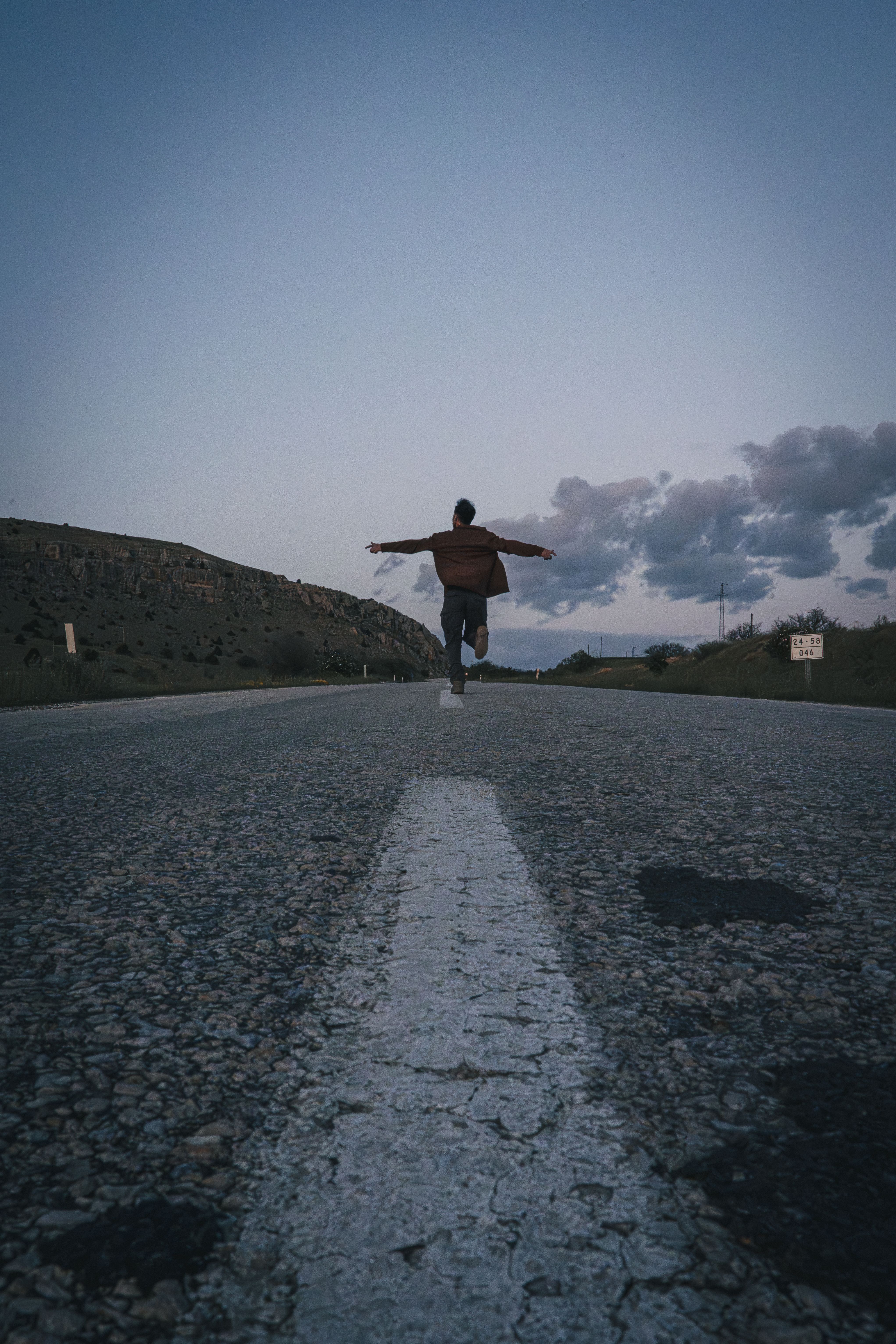 Man Running down a Highway · Free Stock Photo