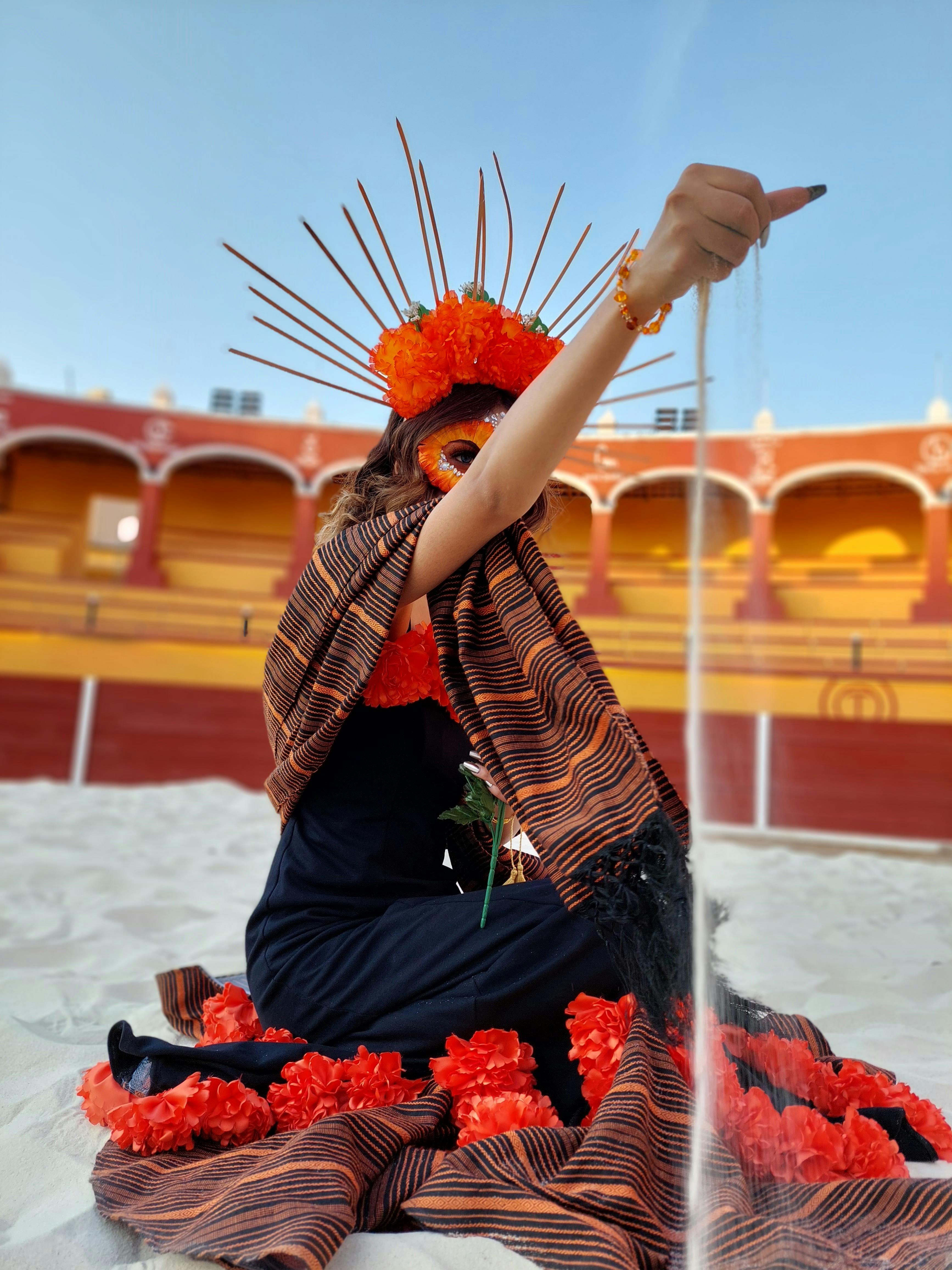 Woman in Wreath Sprinkles Sand · Free Stock Photo