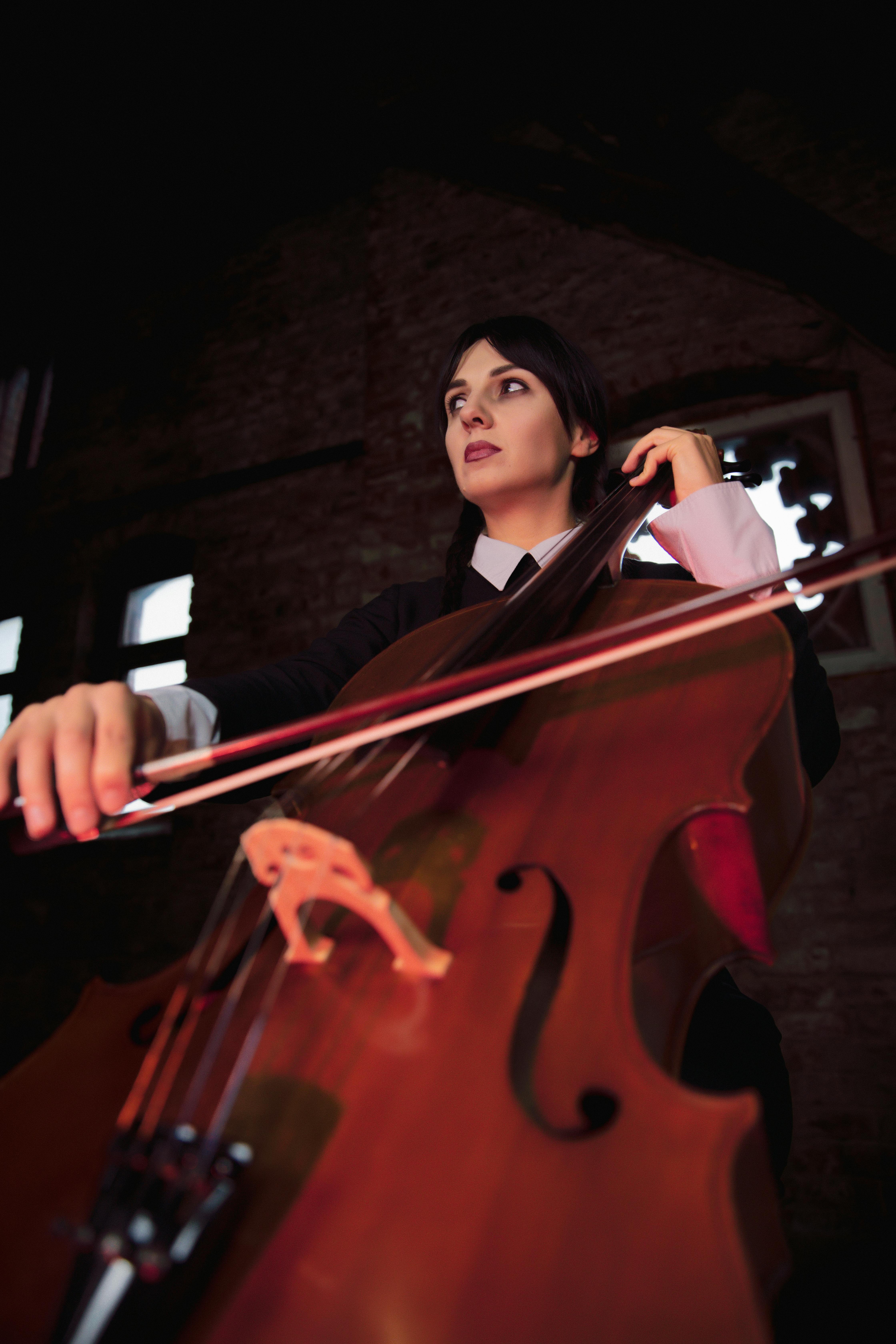 Girl in the Wednesday Addams Costume Playing a Cello · Free Stock Photo