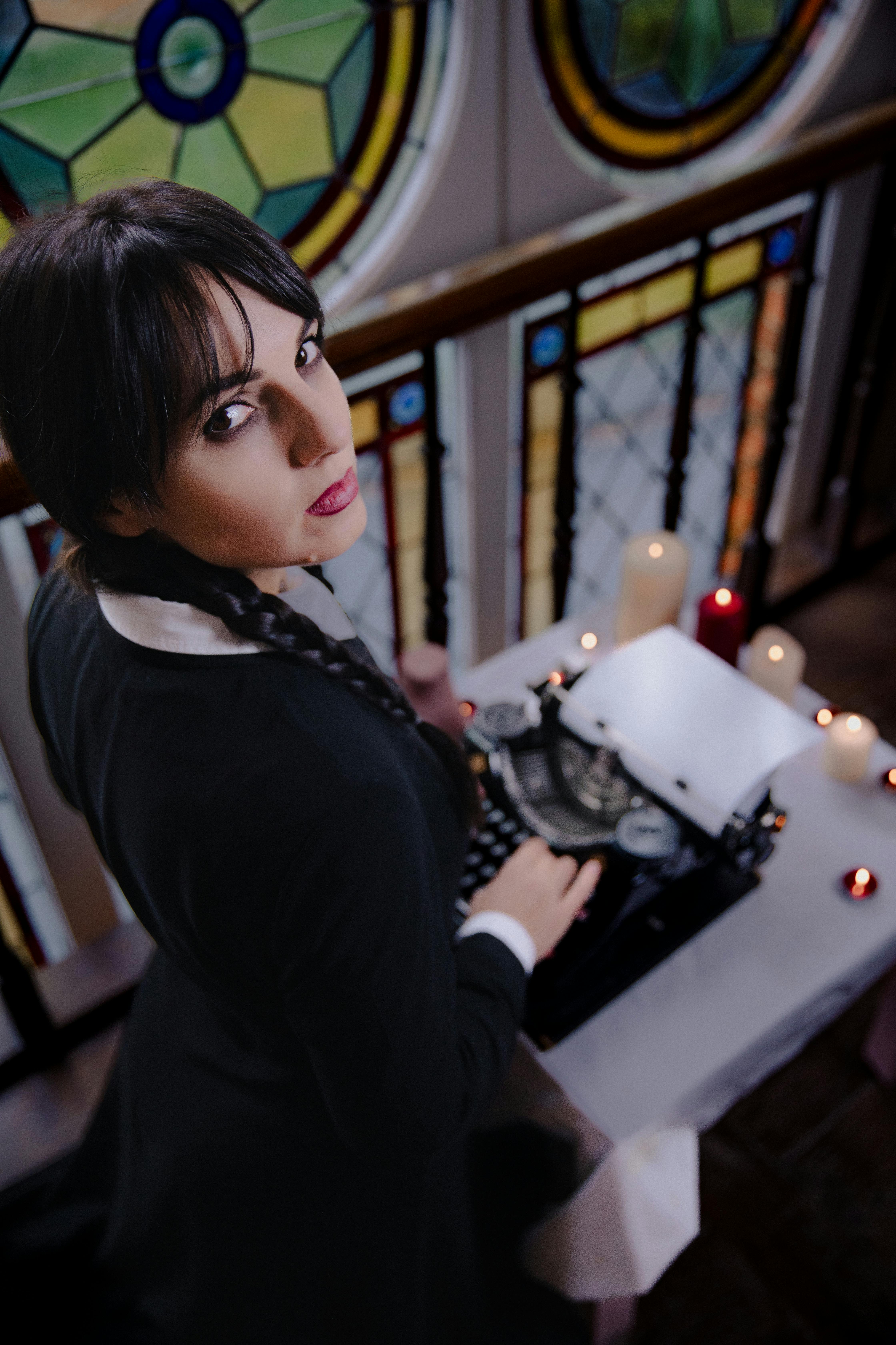 Girl in the Wednesday Addams Costume Writing on a Typewriter · Free ...