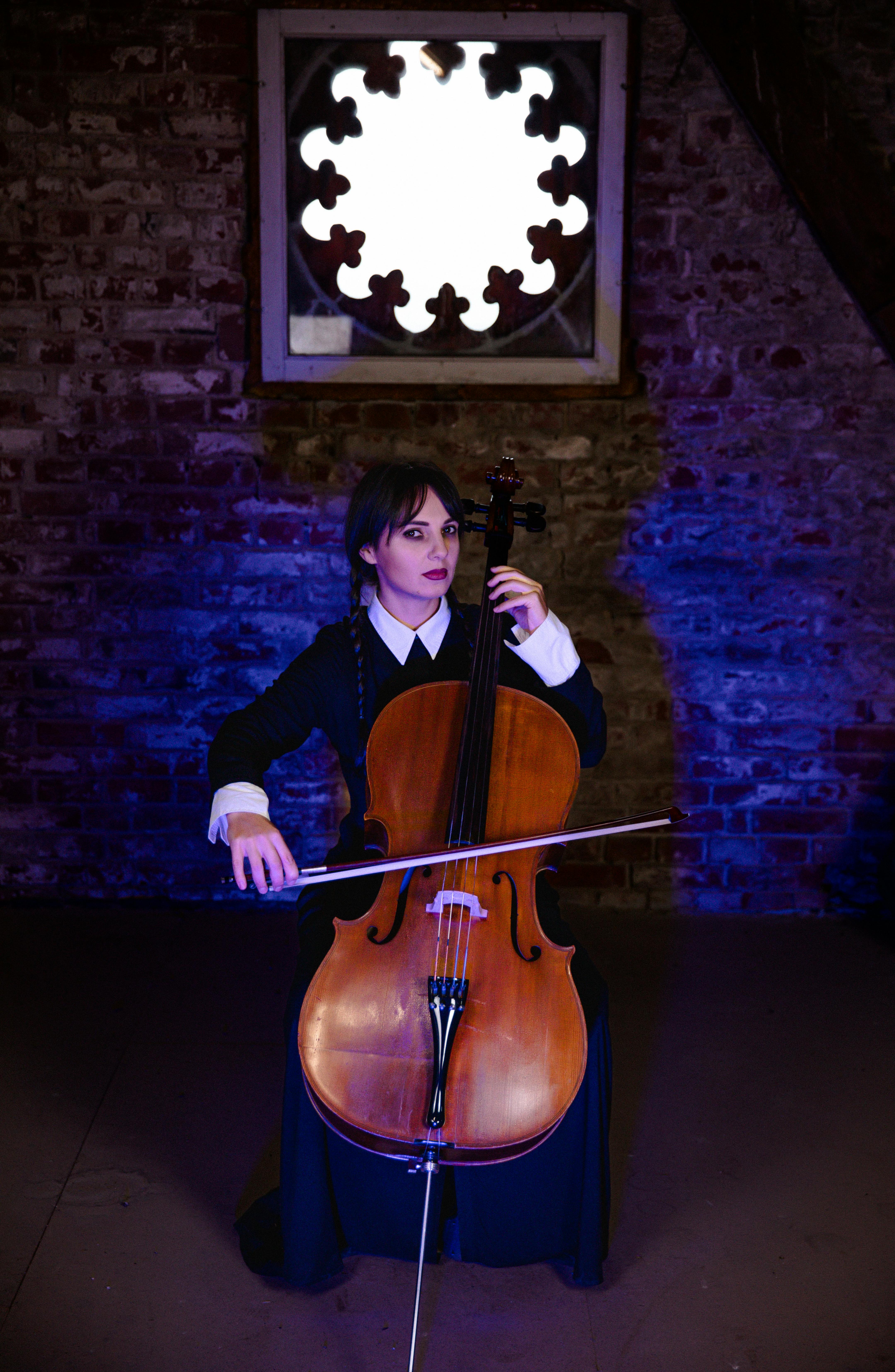 Girl in the Wednesday Addams Costume Playing a Cello · Free Stock Photo