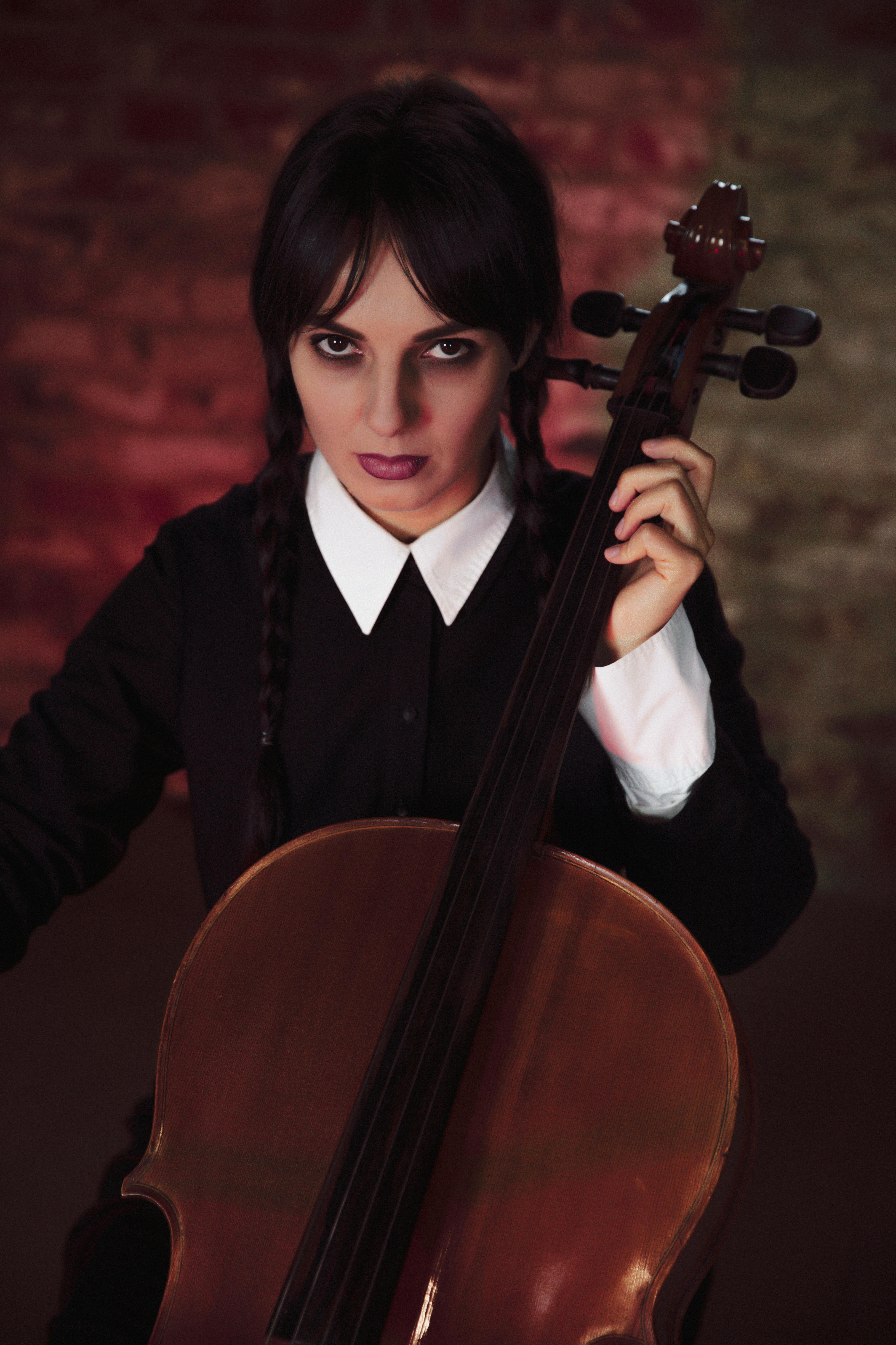 Girl in the Wednesday Addams Costume Playing a Cello · Free Stock Photo