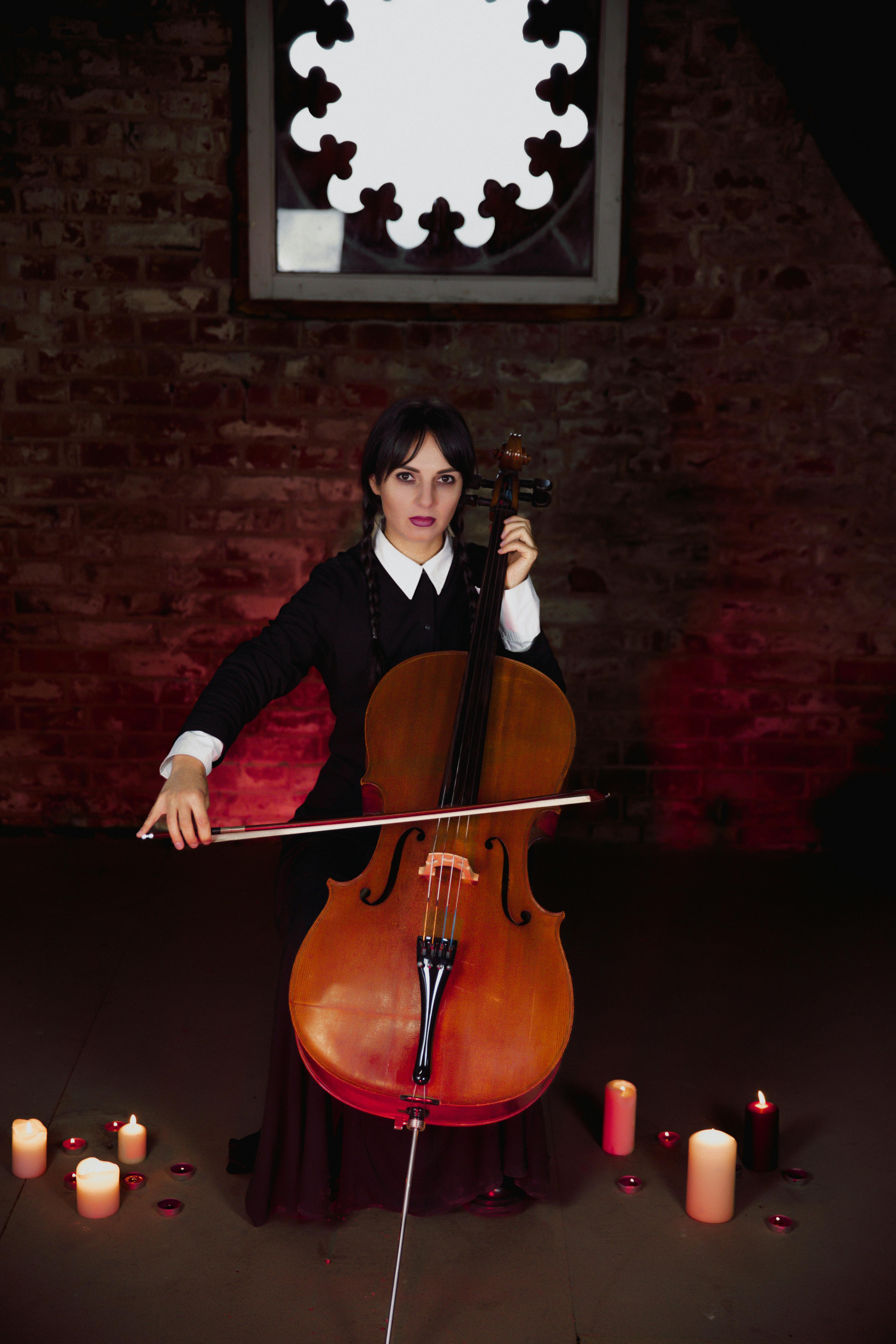 Girl in the Wednesday Addams Costume Playing a Cello · Free Stock Photo