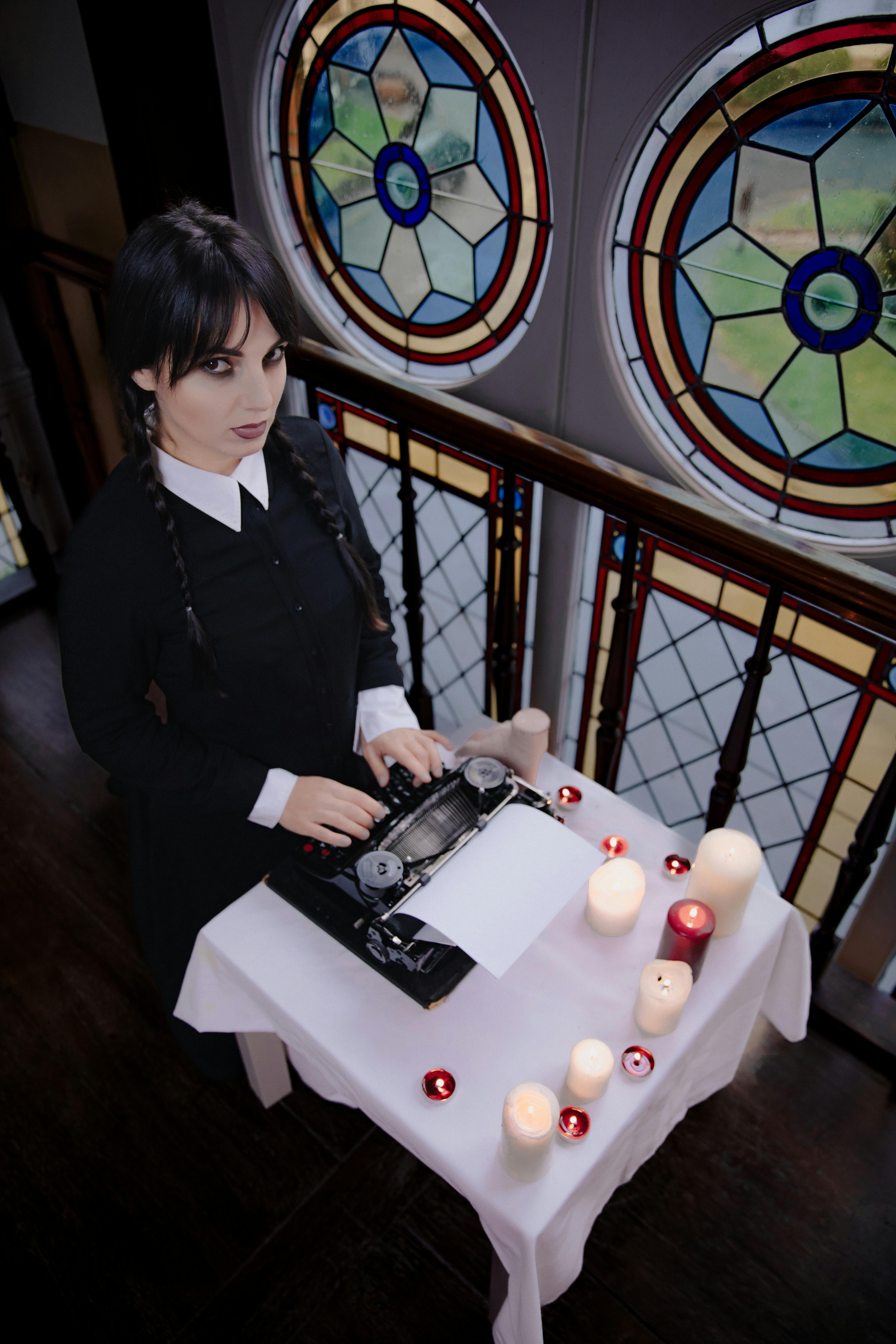 Girl in the Wednesday Addams Costume Writing on a Typewriter · Free ...