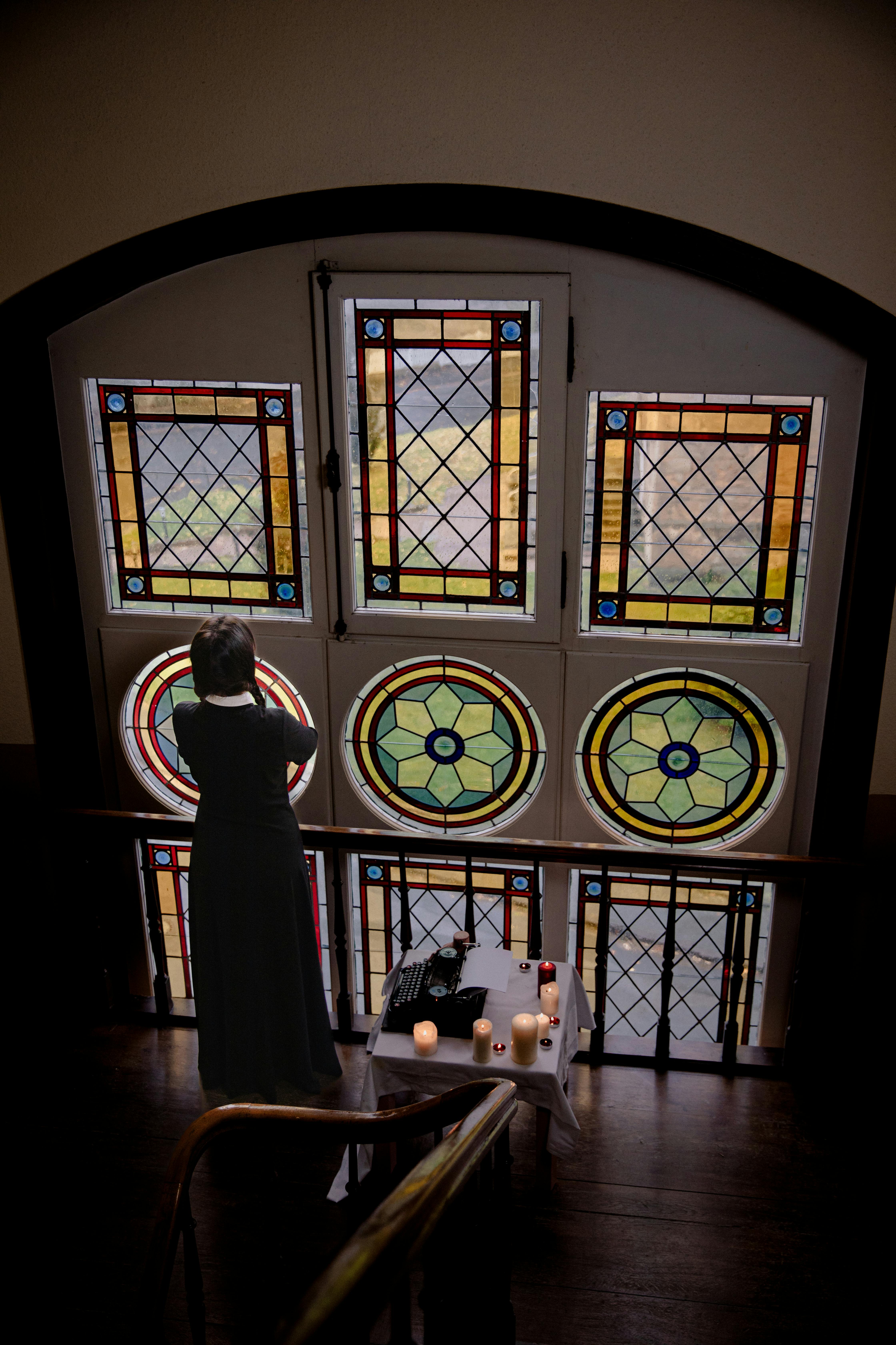 Girl in the Wednesday Addams Costume Standing by the Window · Free ...