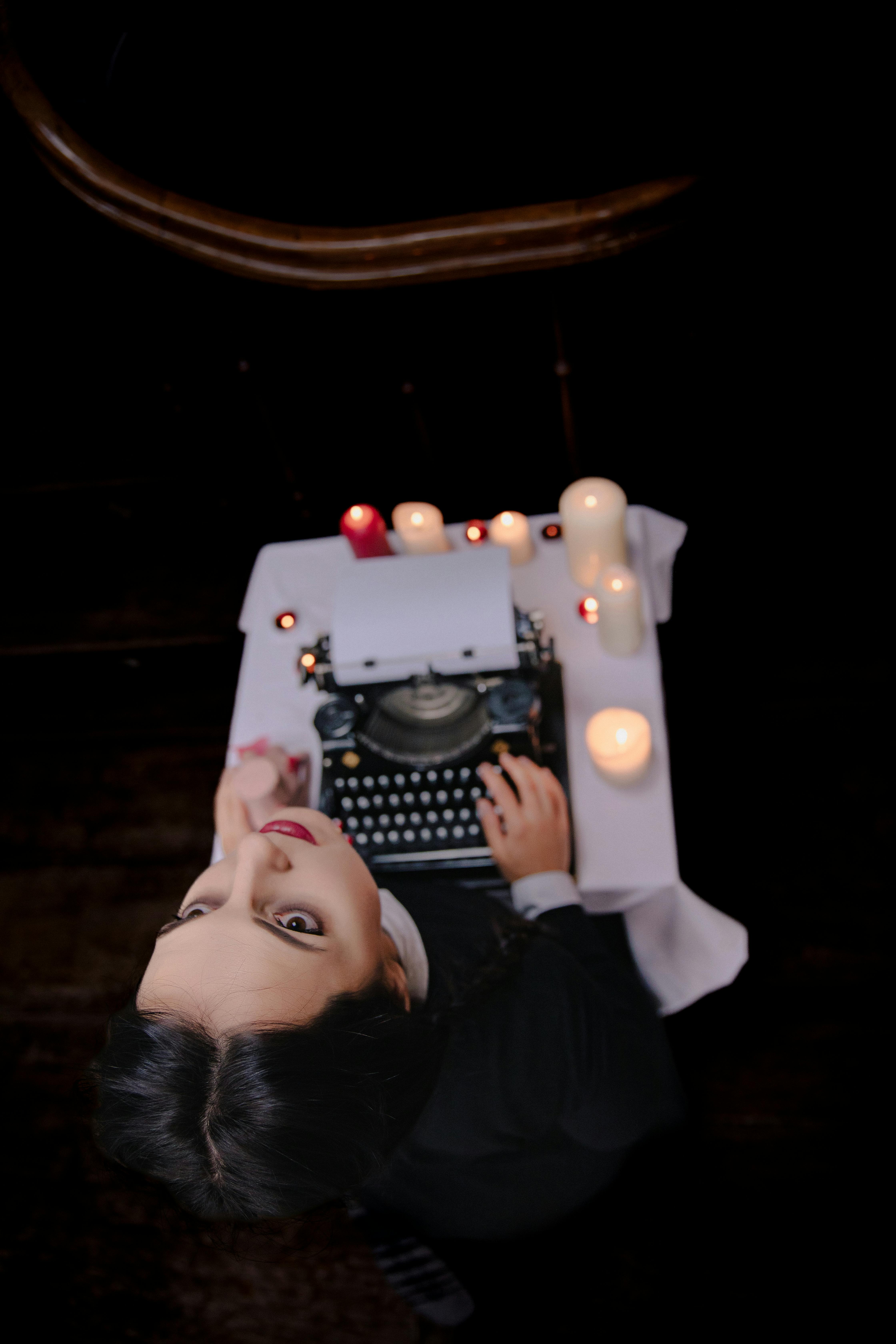 Girl in the Wednesday Addams Costume Writing on a Typewriter · Free ...