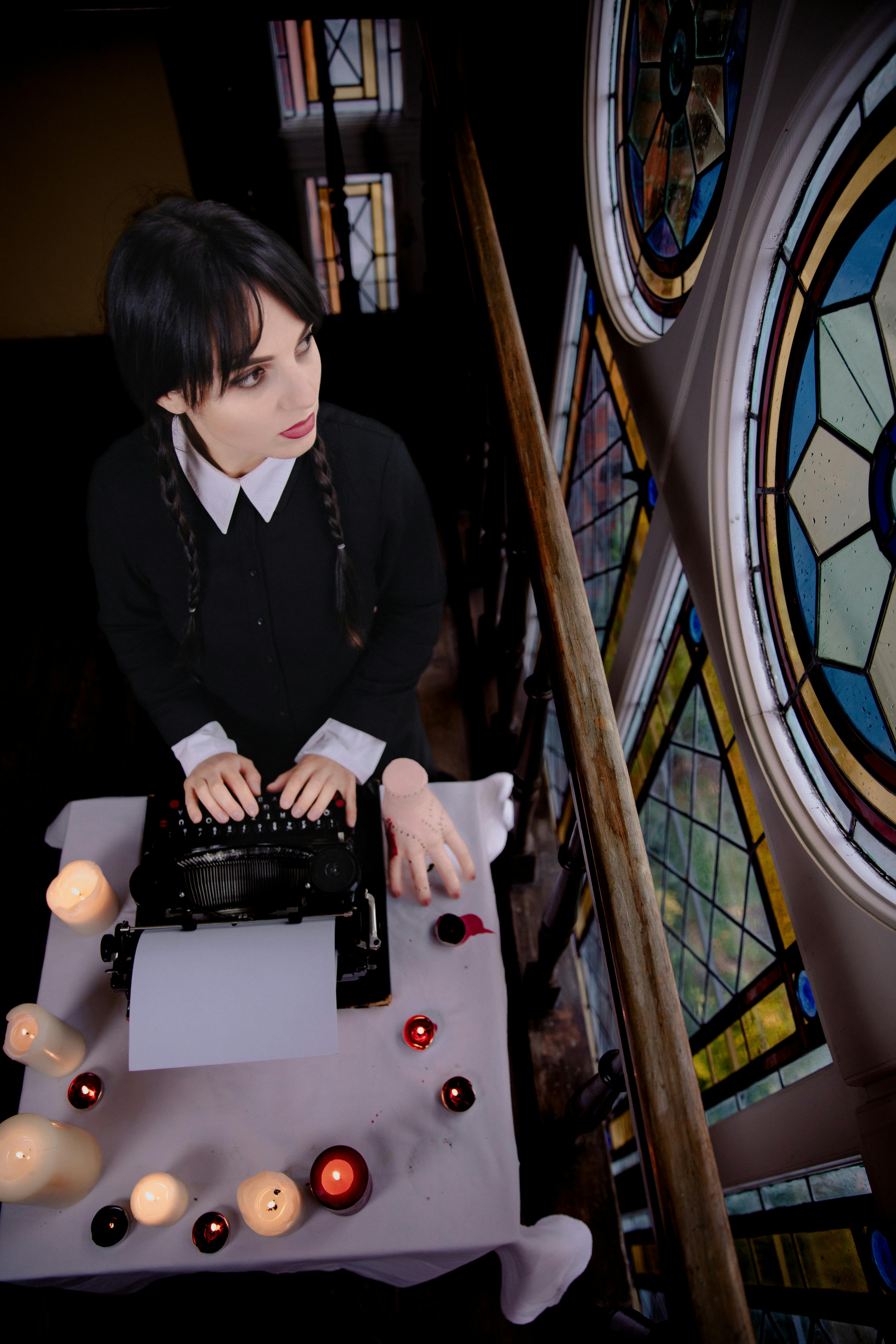 Girl in the Wednesday Addams Costume Writing on a Typewriter · Free ...