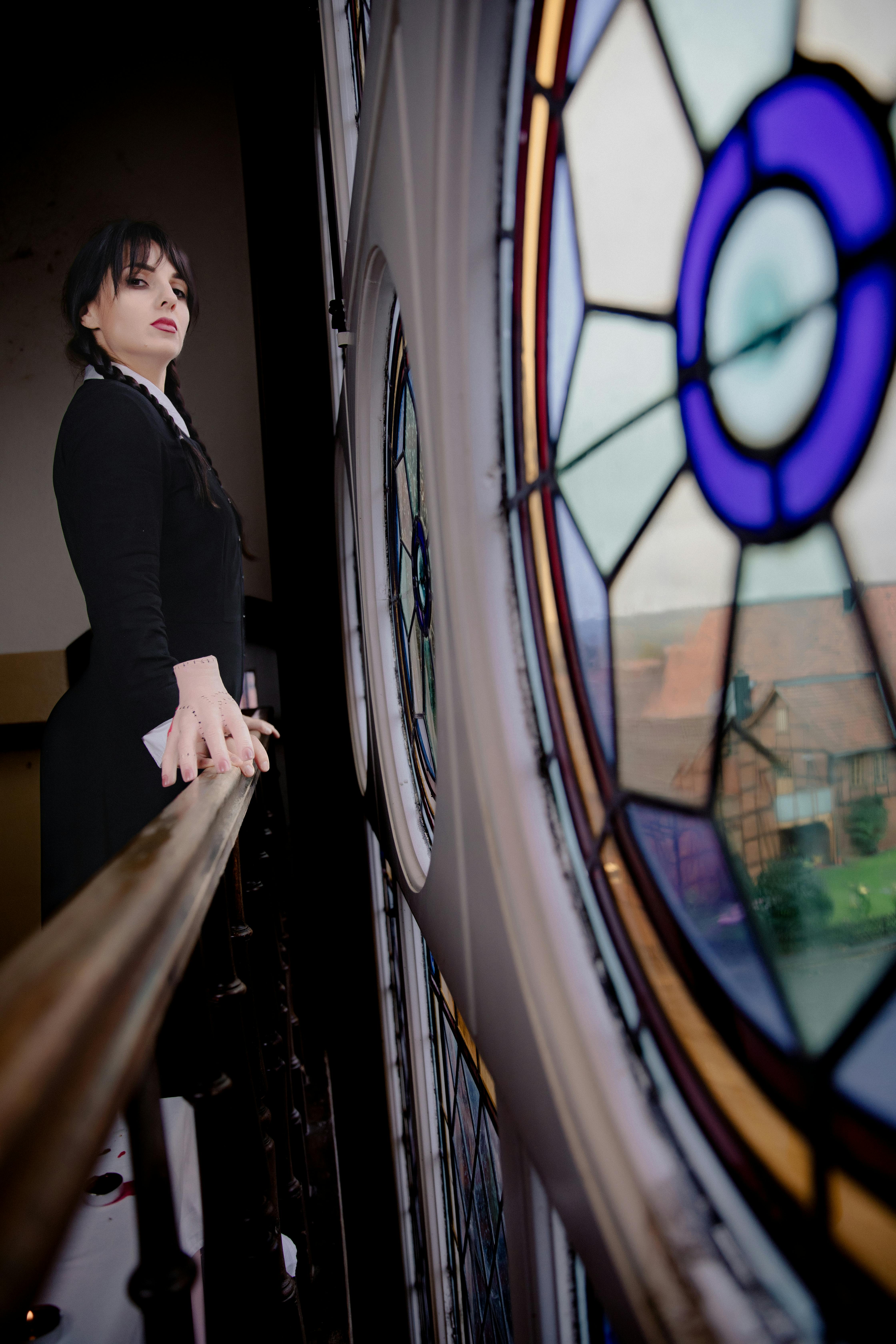 Woman Standing near Stained Glass Windows · Free Stock Photo