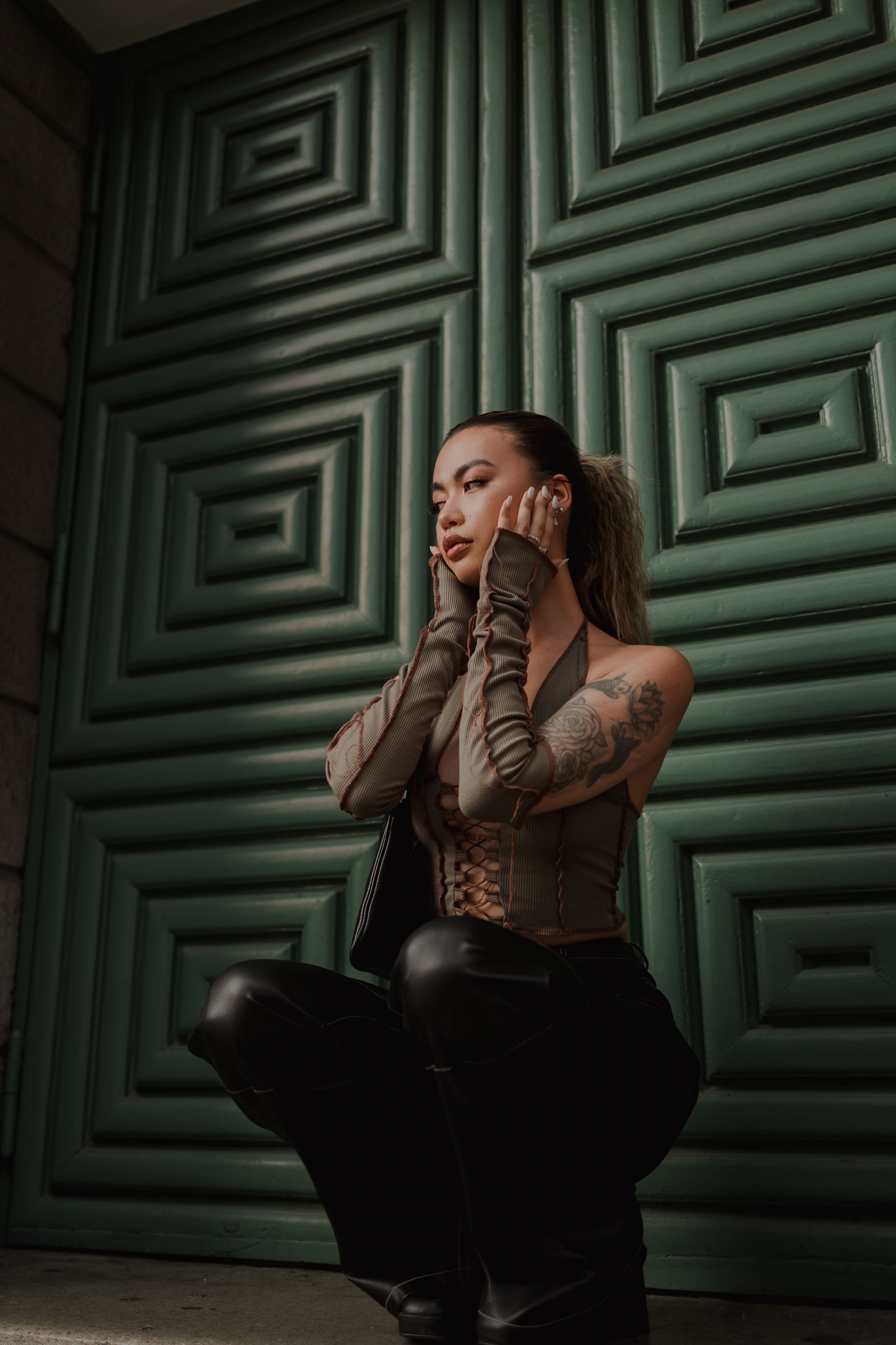 Model in Green Top and Leather Pants · Free Stock Photo