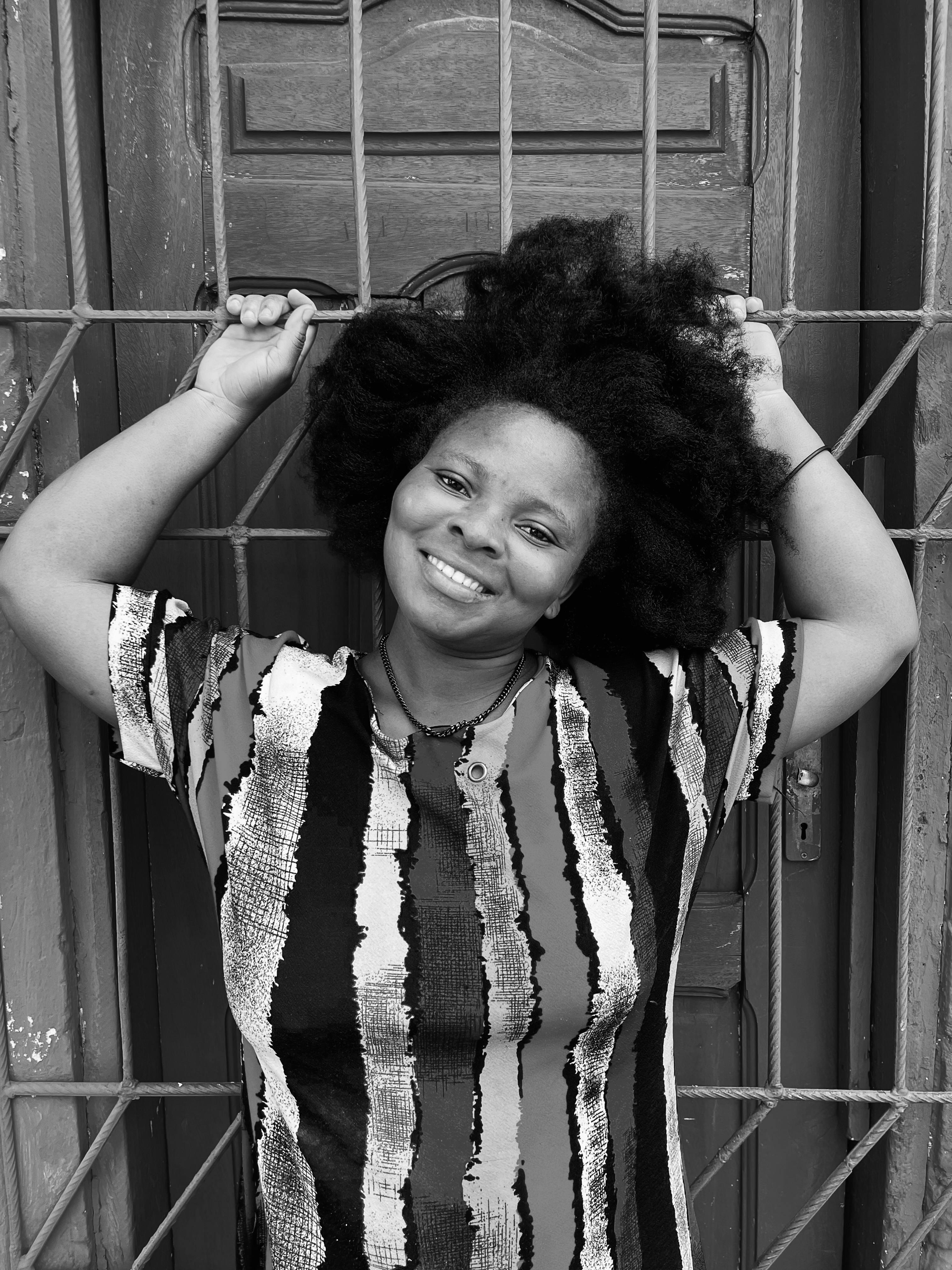 A Grayscale of Handcuffs on Steel Bars · Free Stock Photo