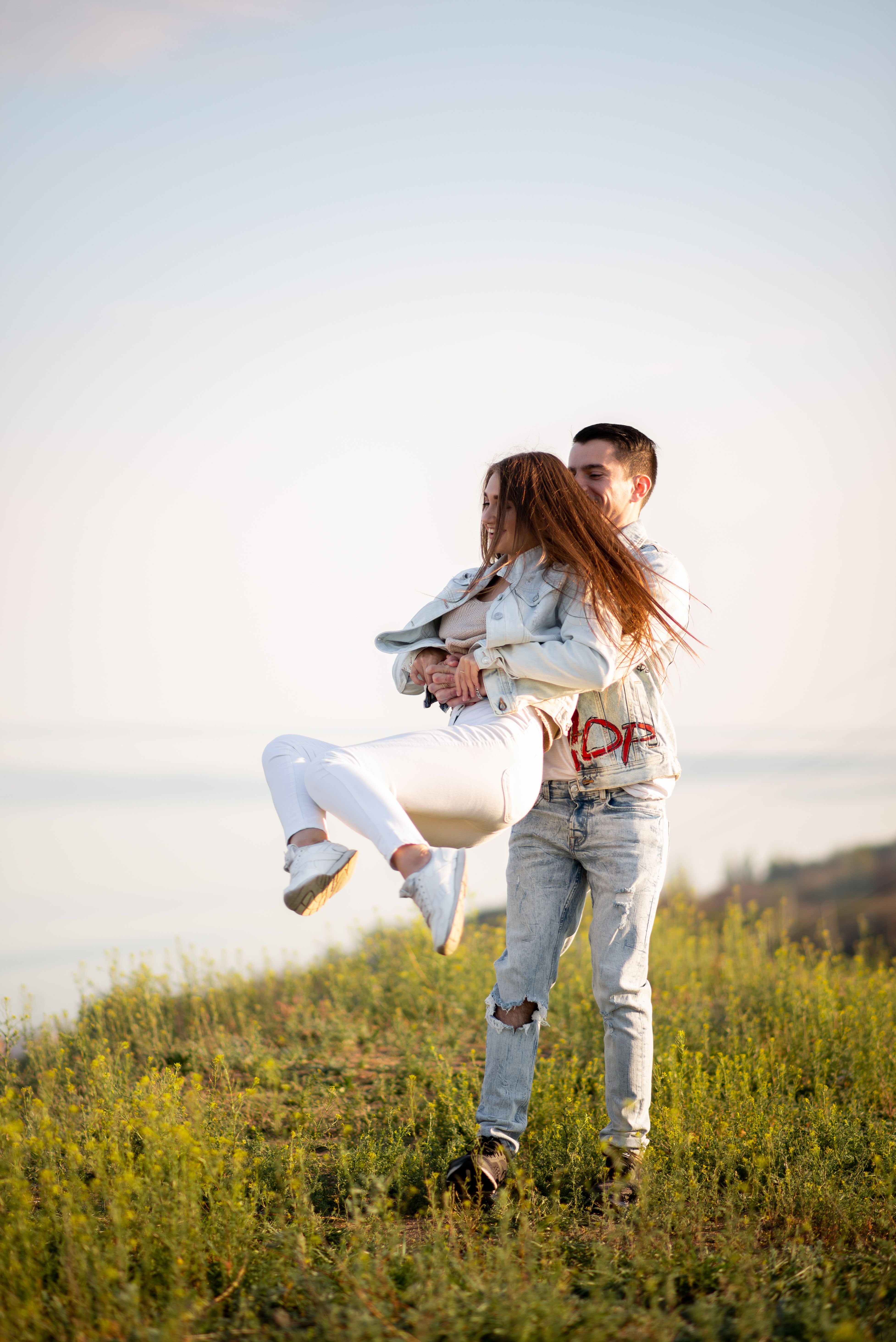Man Lifting Woman on Sea Coast · Free Stock Photo