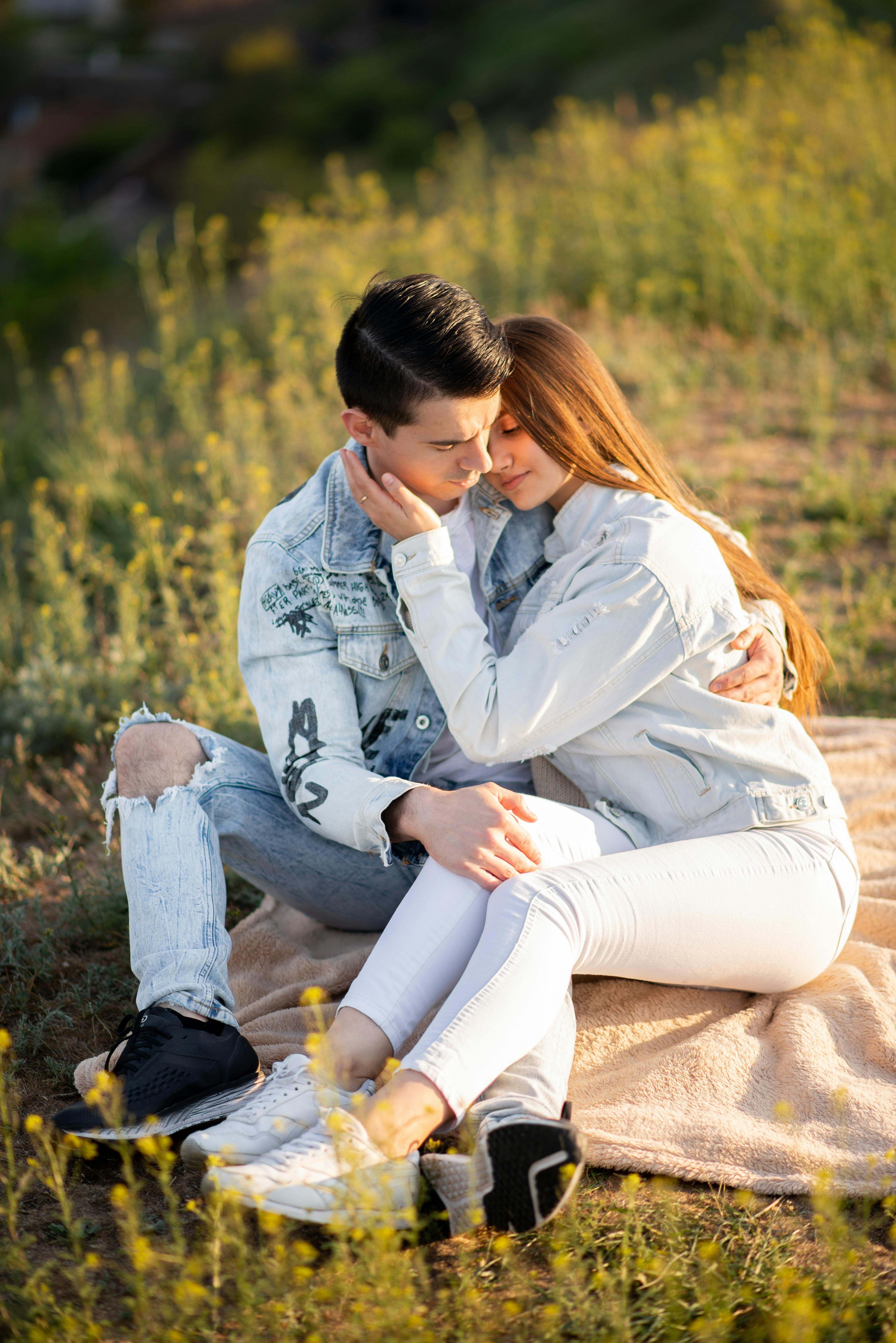 Couple Sitting and Hugging on Meadow · Free Stock Photo