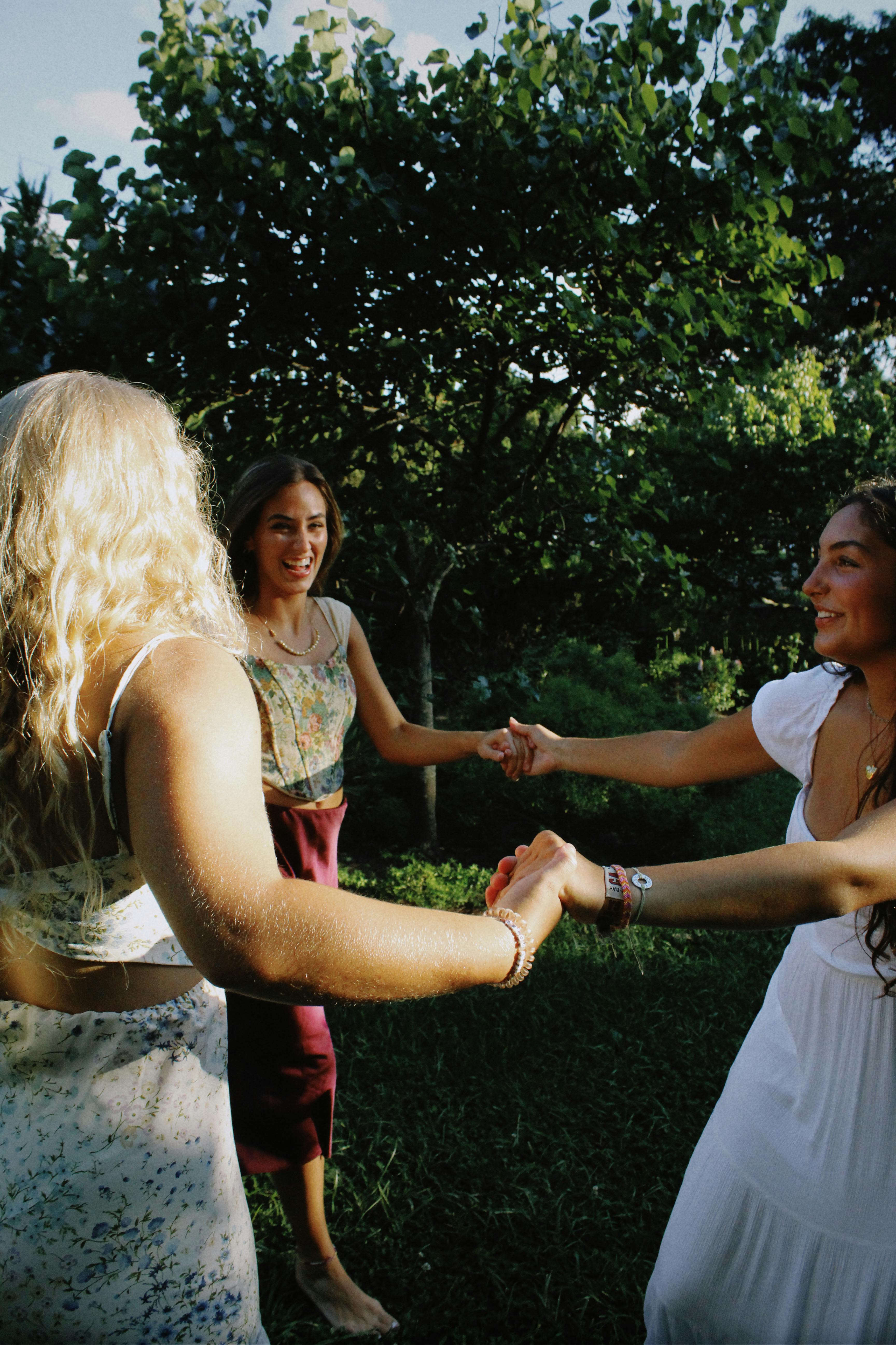 Young Women Holding Hands and Dancing in a Circle · Free Stock Photo