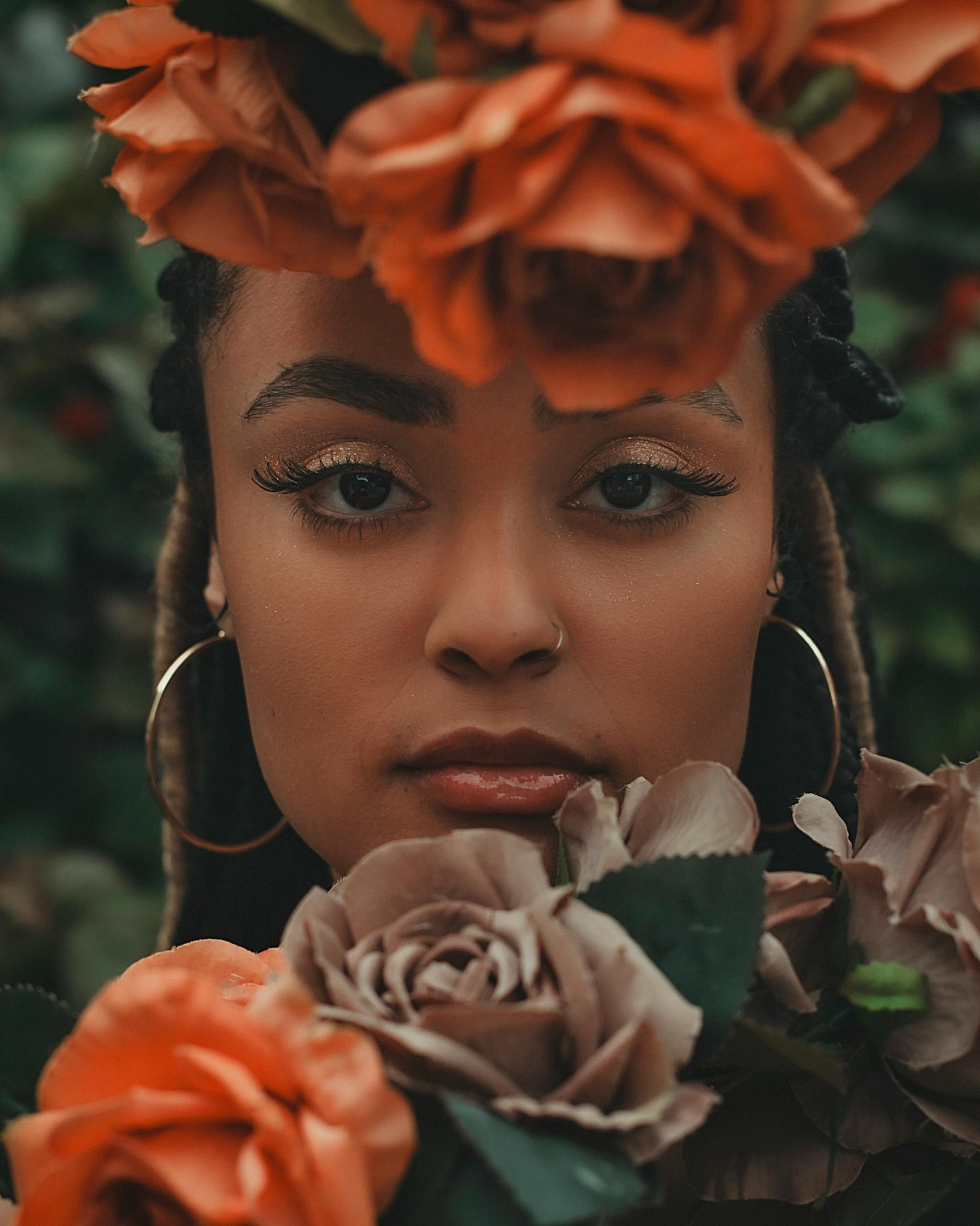 Portrait of a Young Woman with Flowers around Her Face · Free Stock Photo