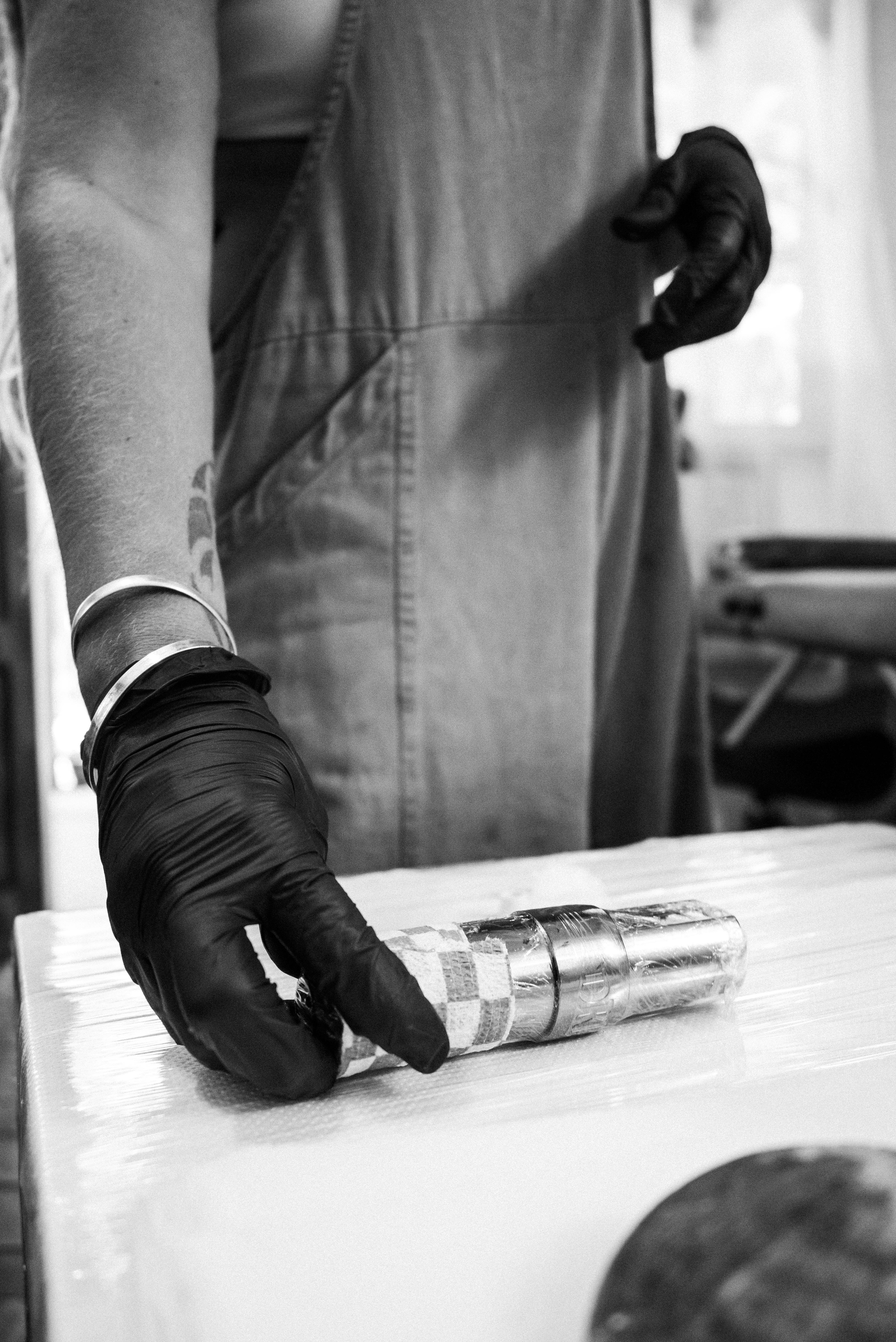 Person in Gloves Placing Something on Table · Free Stock Photo